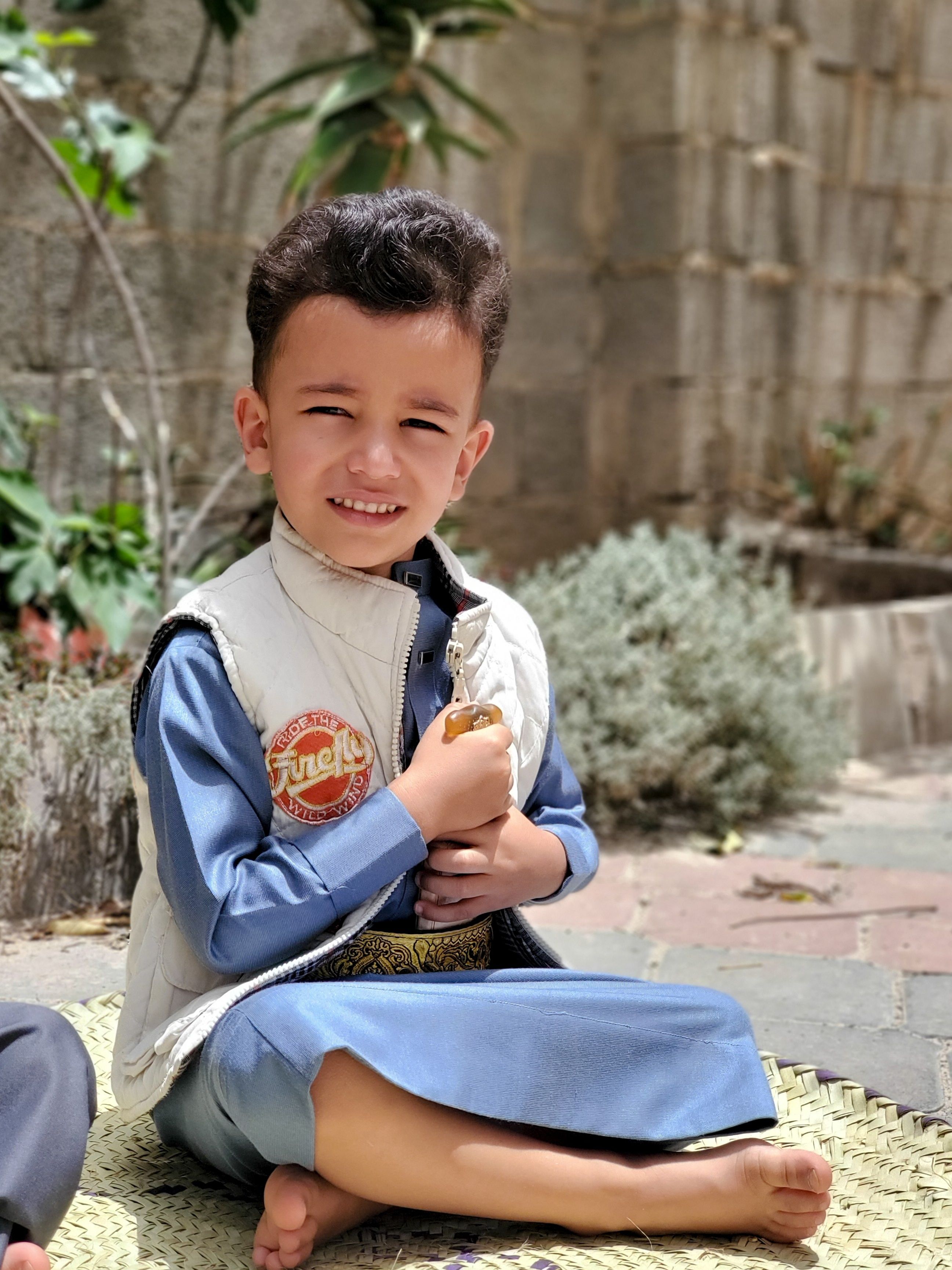 Smiling Boy in Traditional Yemeni Attire · Free Stock Photo