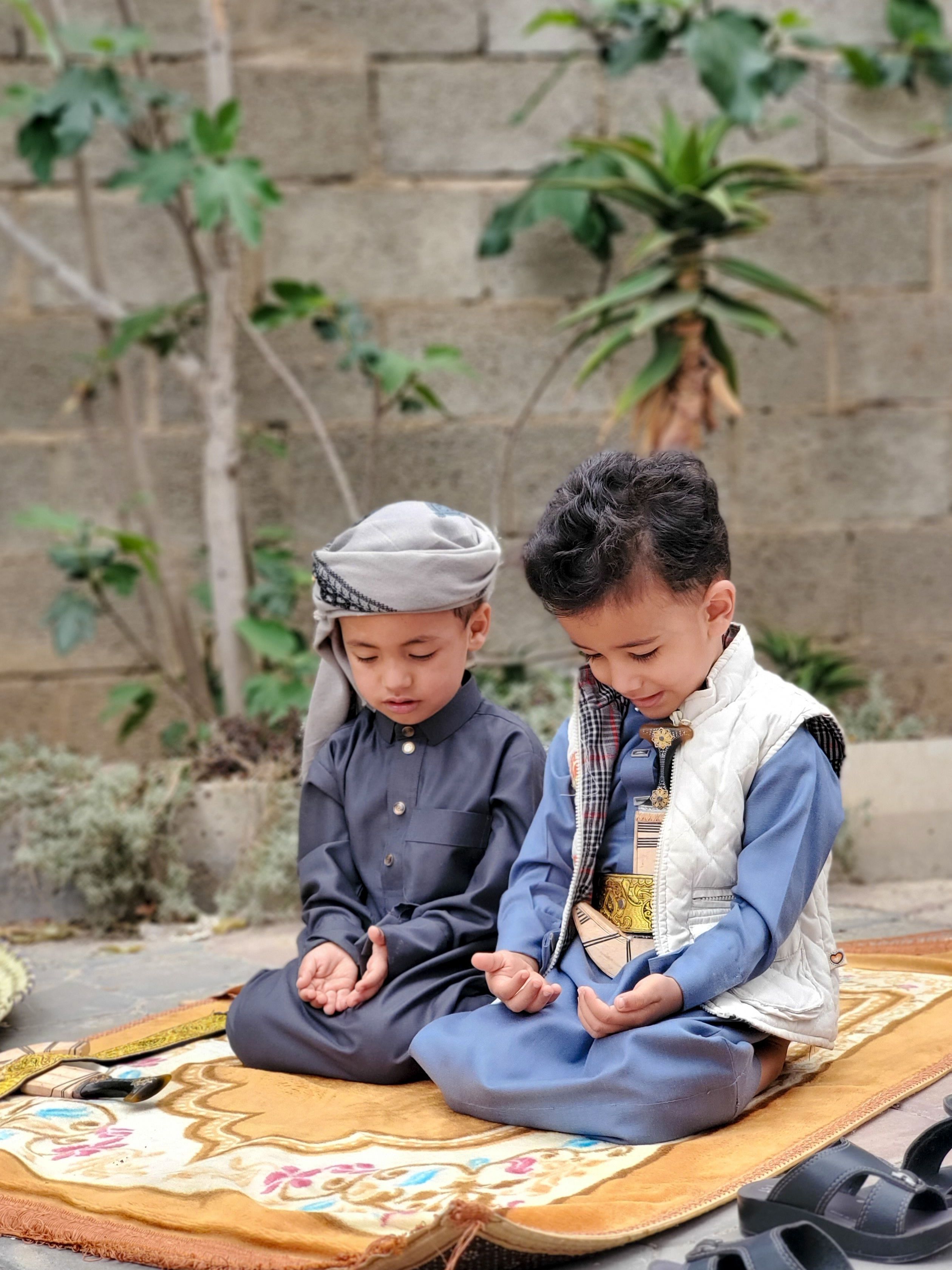 Children Praying in Traditional Dress Outdoors · Free Stock Photo