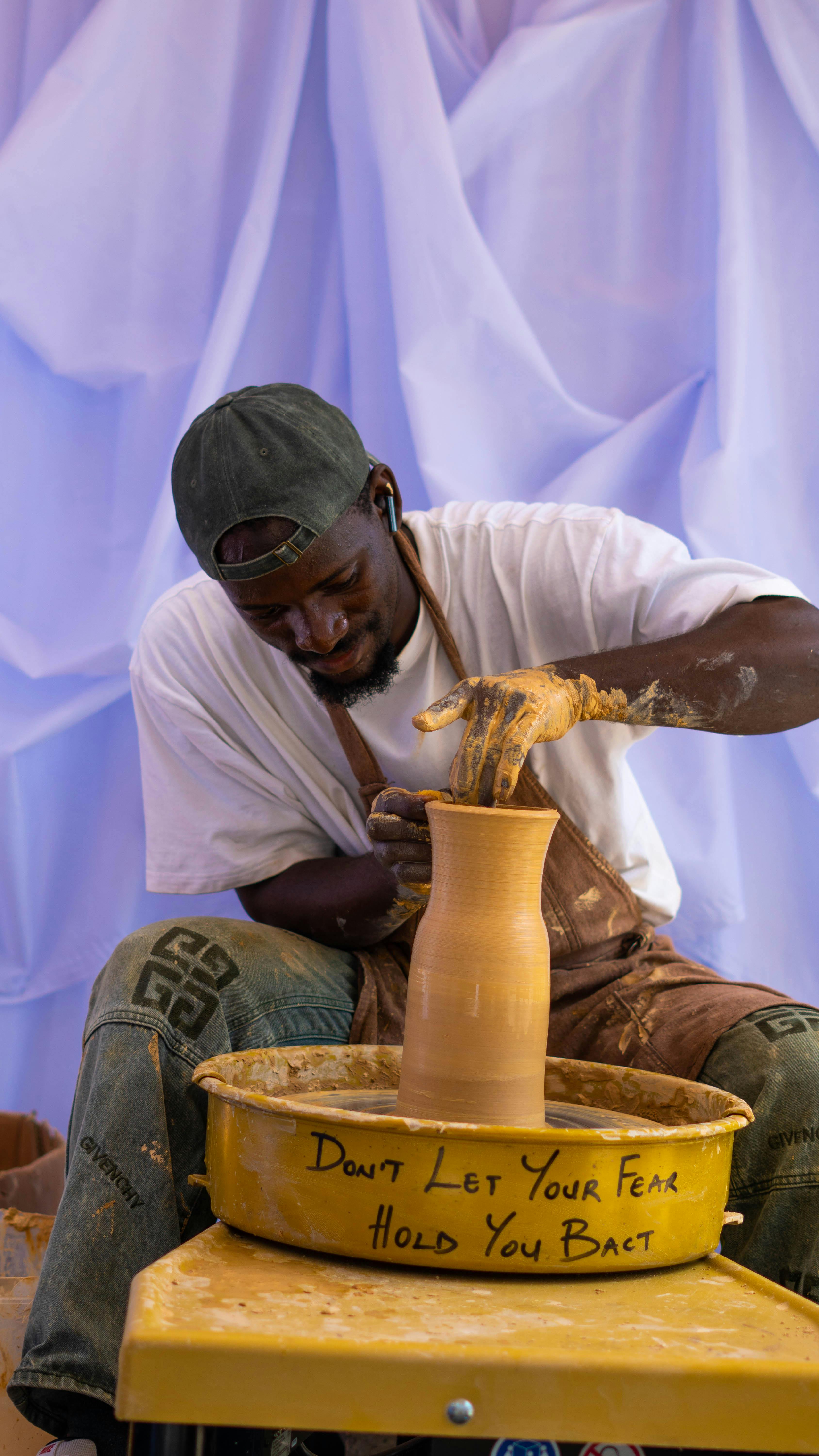 Man Practicing Pottery in Rustic Studio · Free Stock Photo