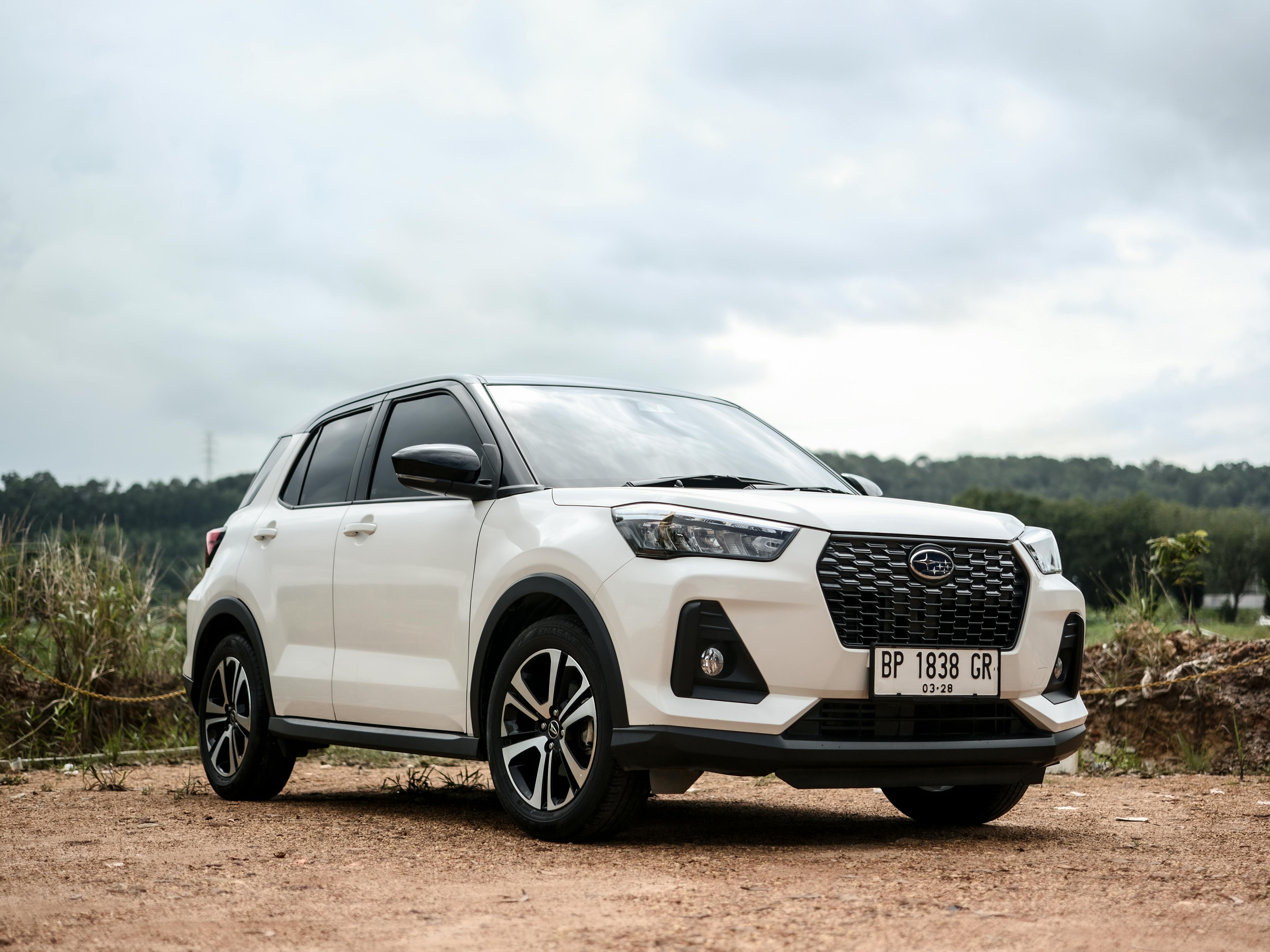 White Compact SUV in Scenic Outdoor Setting · Free Stock Photo