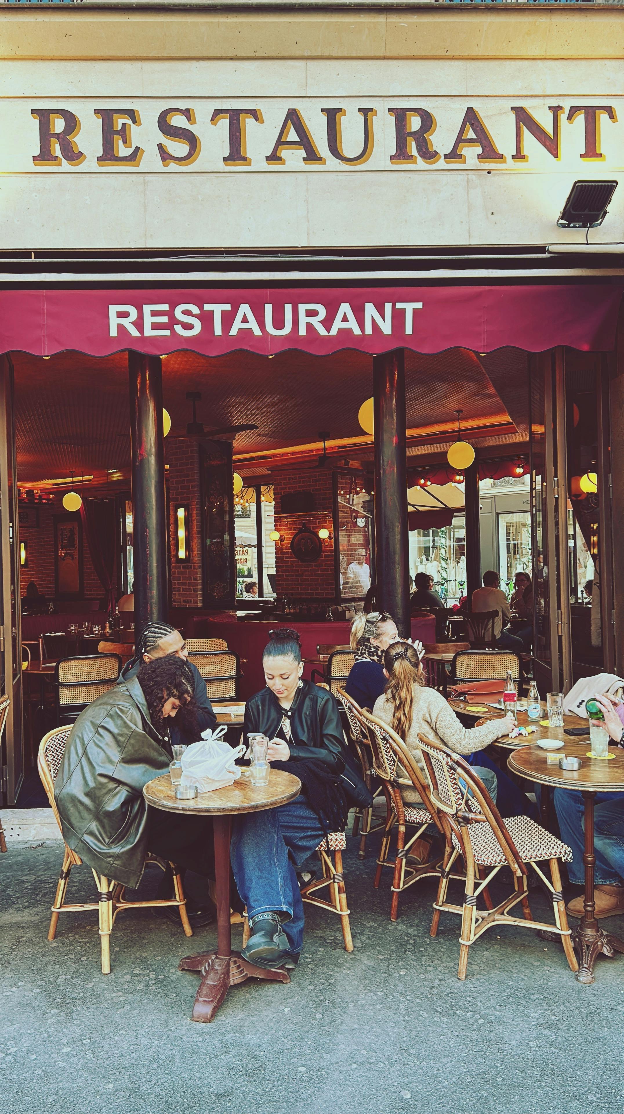 Free Charming outdoor seating at a classic Parisian café with patrons ...
