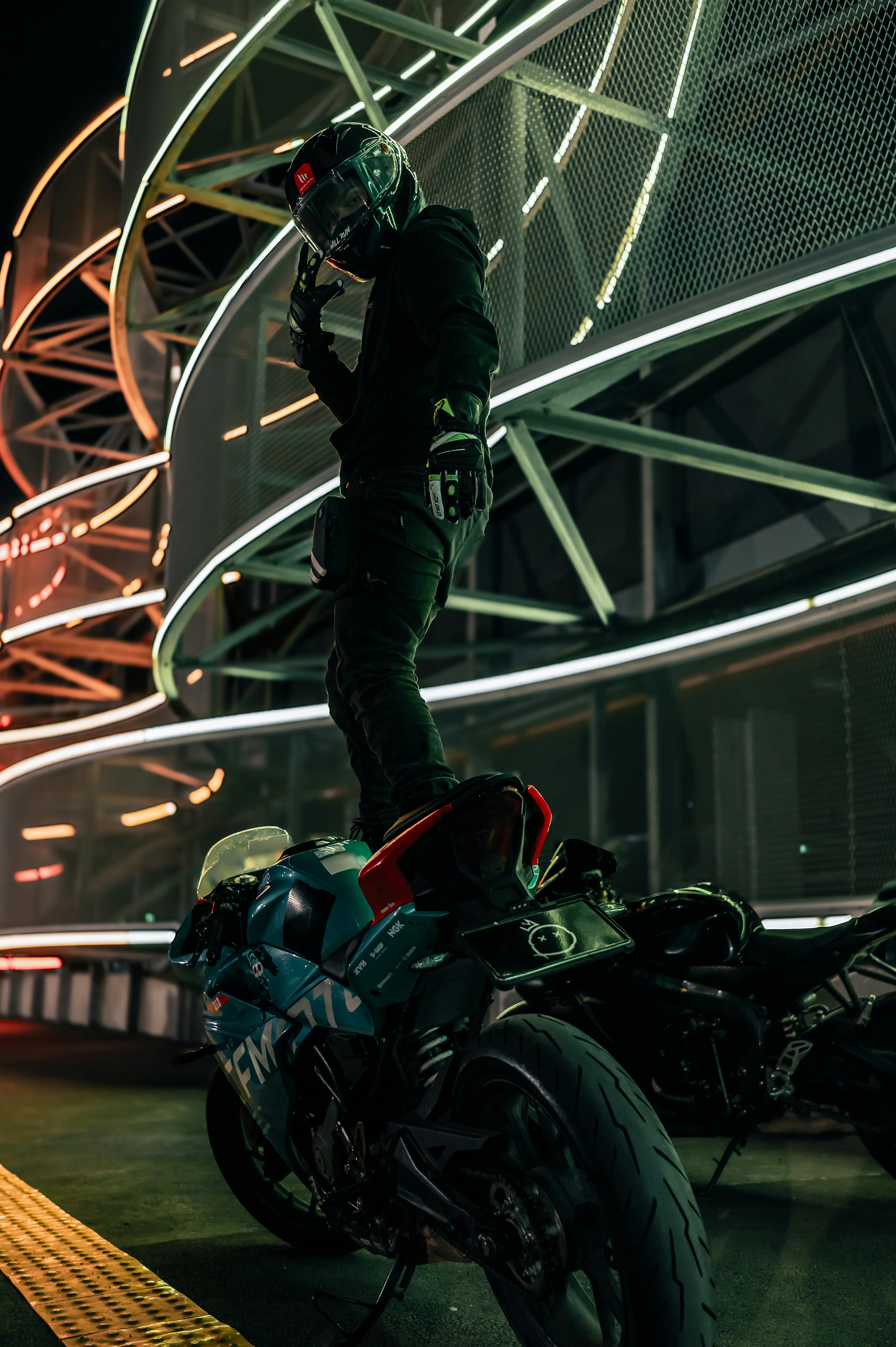 Dramatic Nighttime Motorcycle Stunt in Urban Setting · Free Stock Photo