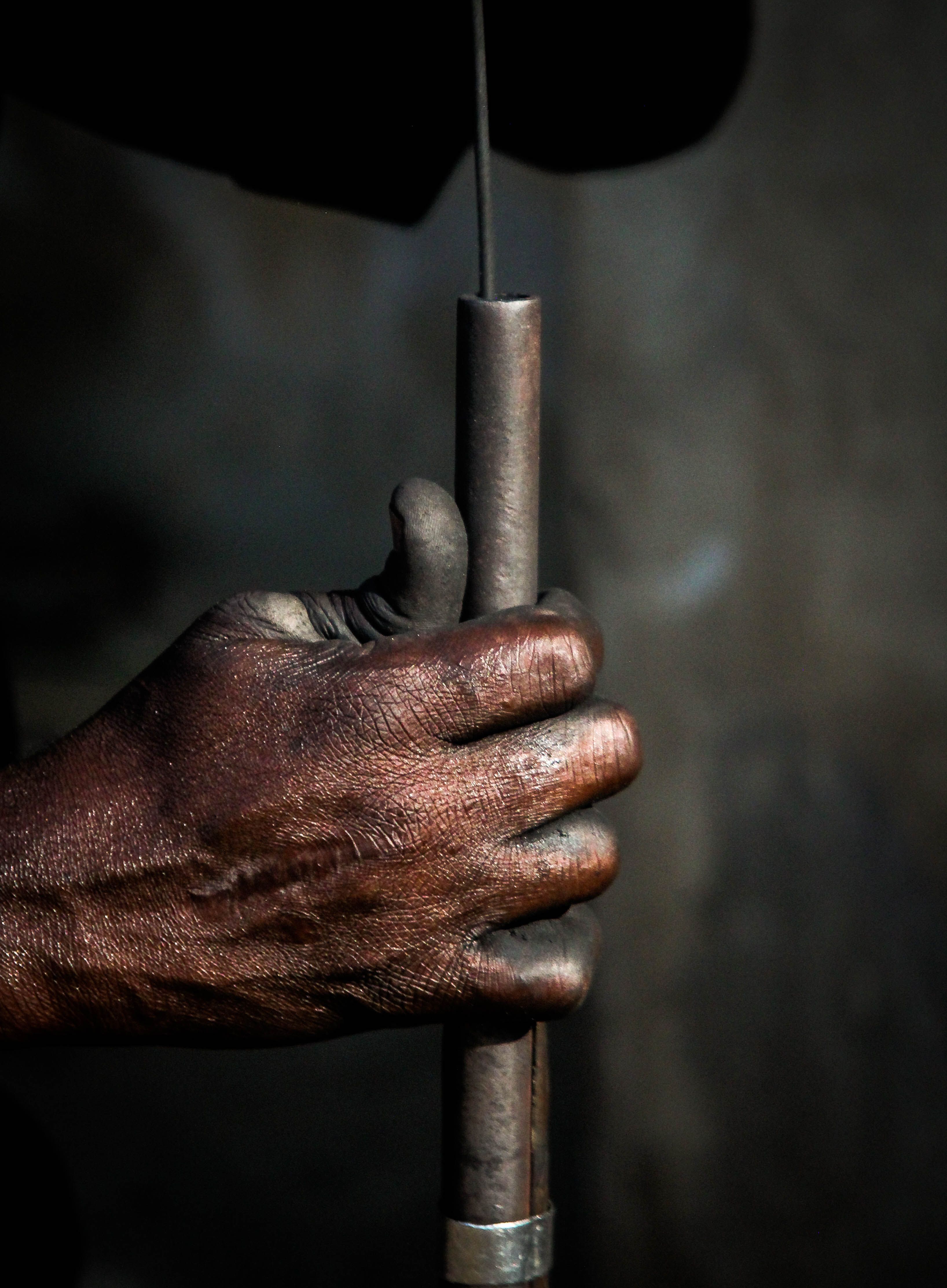 Close-up of Rustic Hands Holding Metal Bar · Free Stock Photo