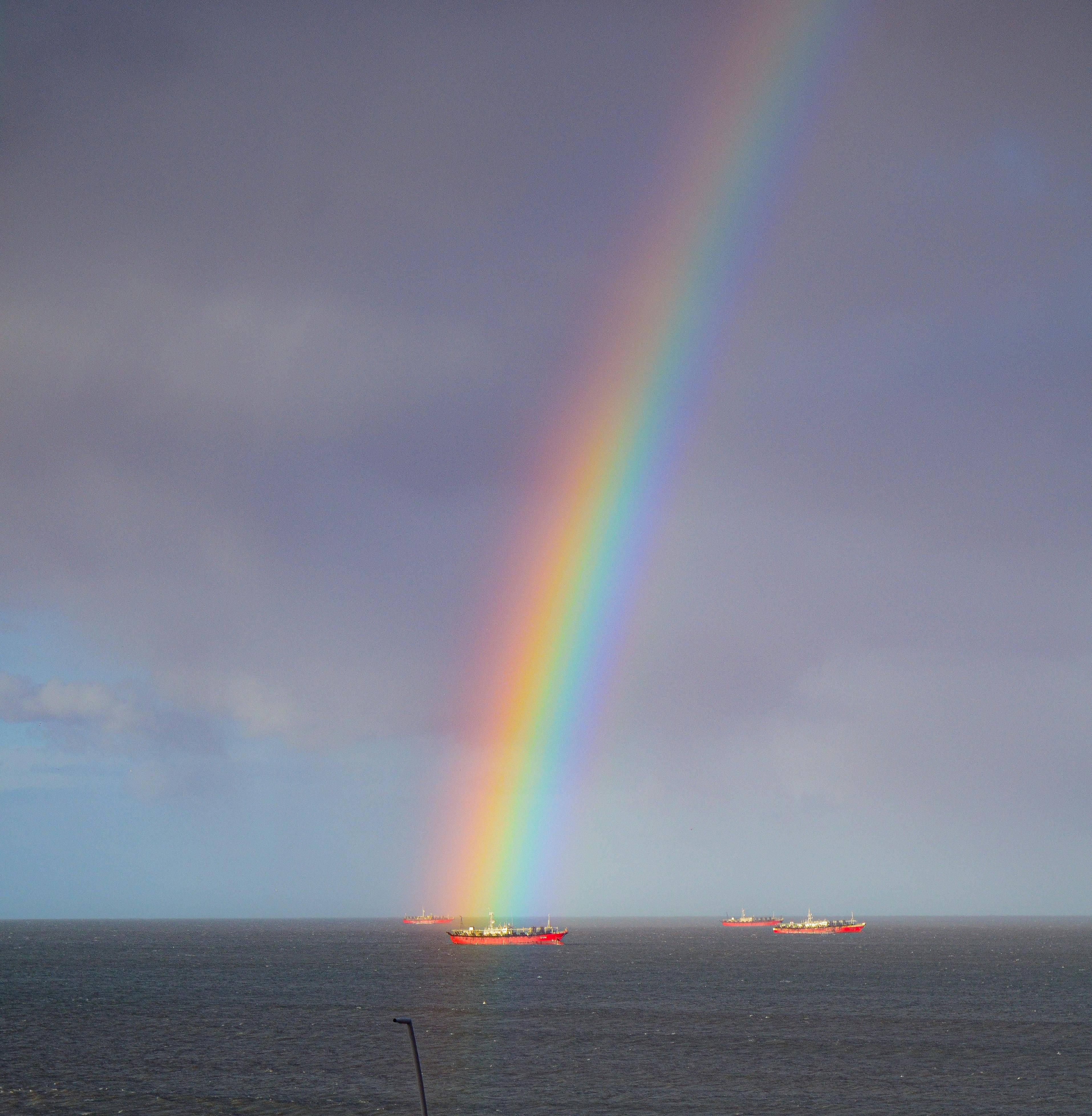 Vibrant Rainbow Over Ocean Capturing Ships · Free Stock Photo