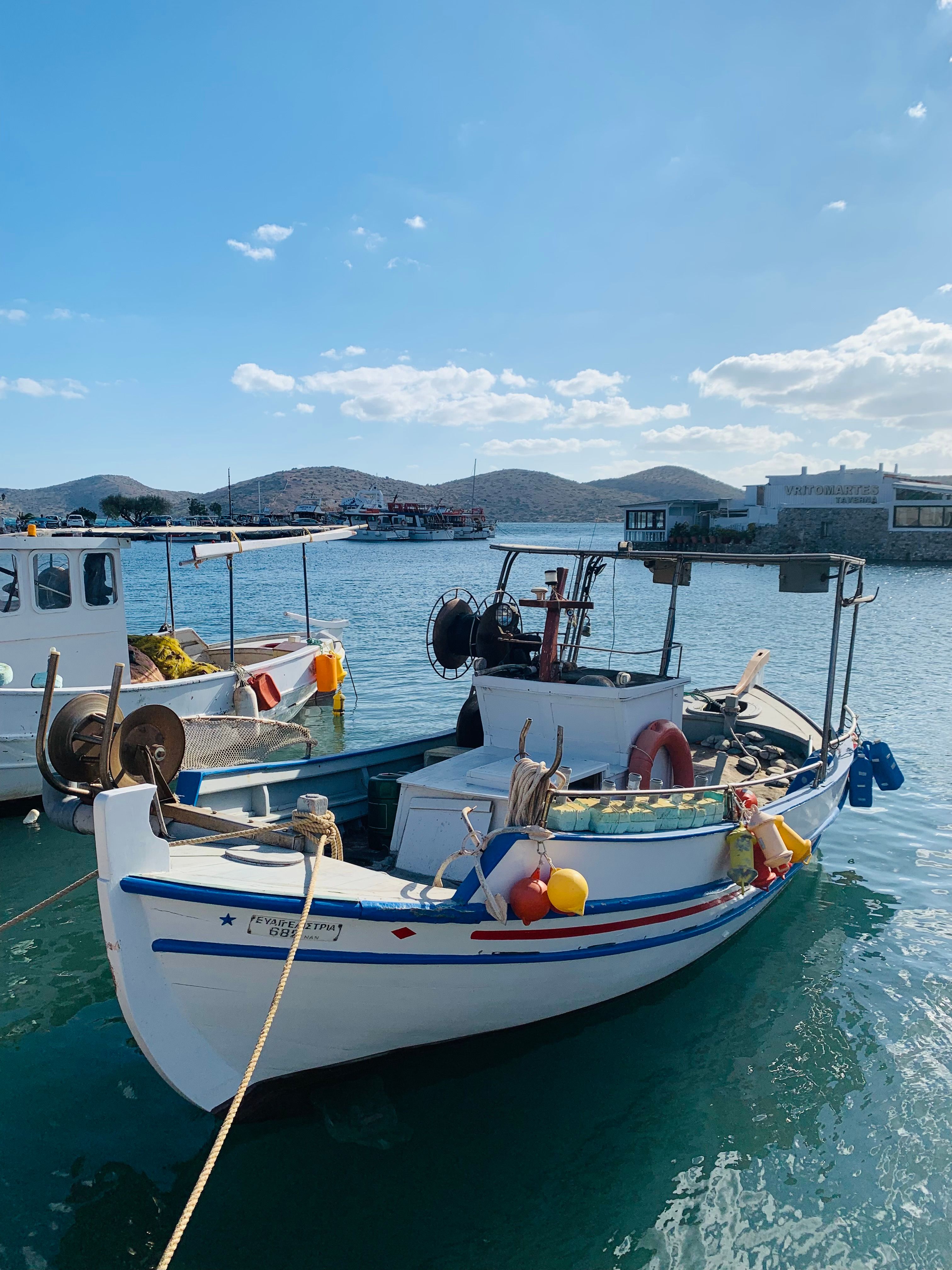 Traditional Fishing Boats in Serene Greek Harbor · Free Stock Photo