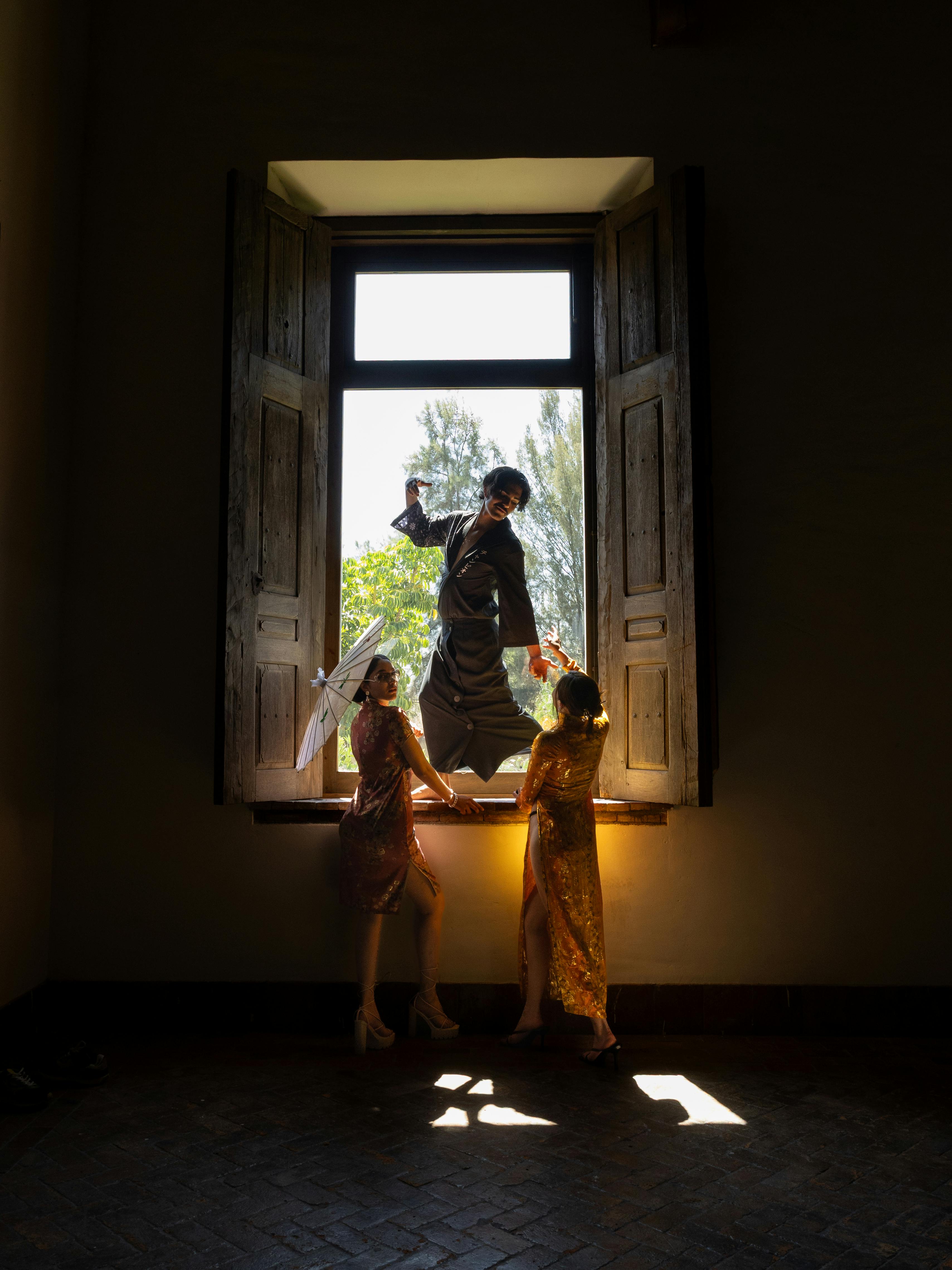Dramatic Portrait of People in Window Frame · Free Stock Photo
