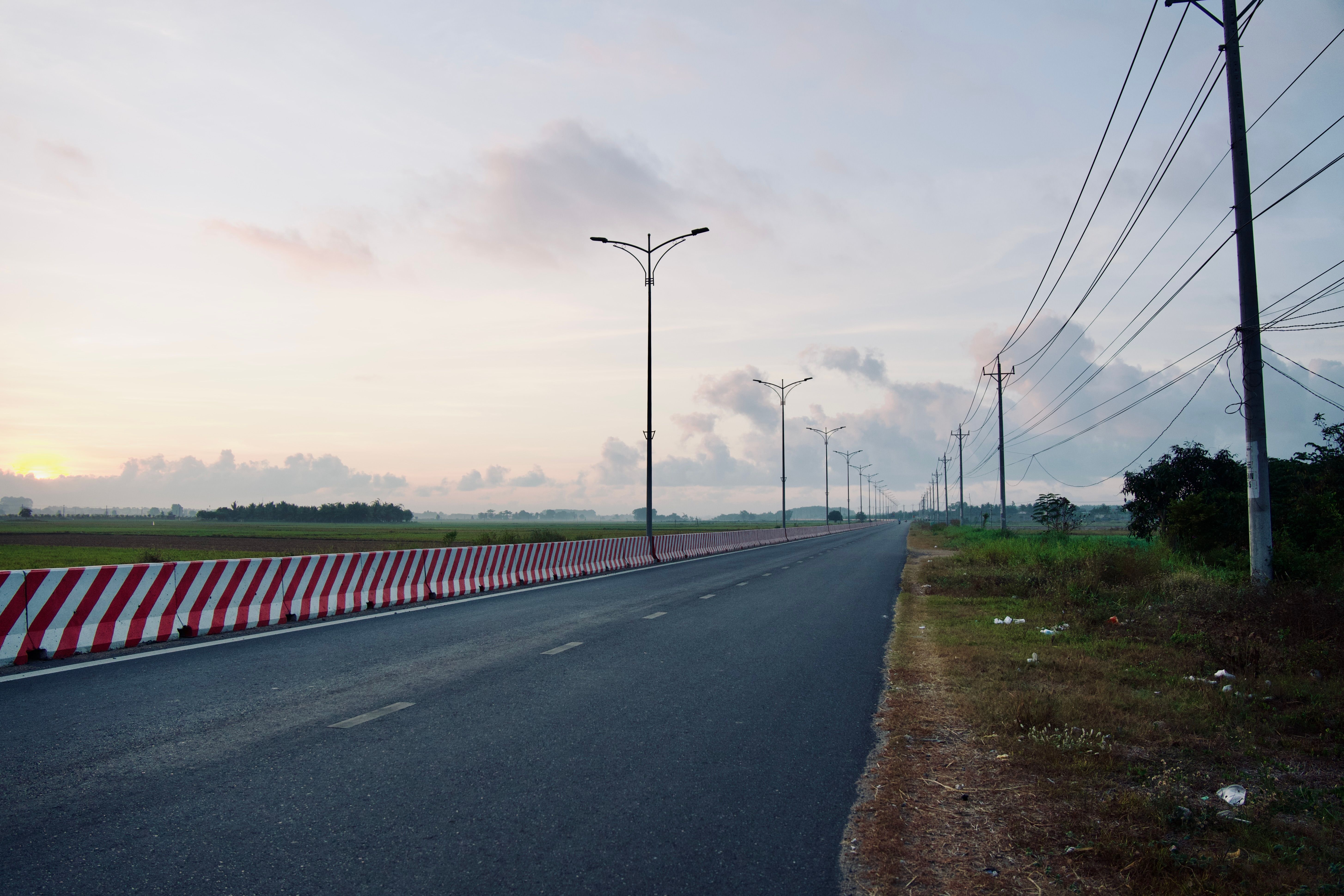 Desolate Road at Dawn with Power Lines · Free Stock Photo
