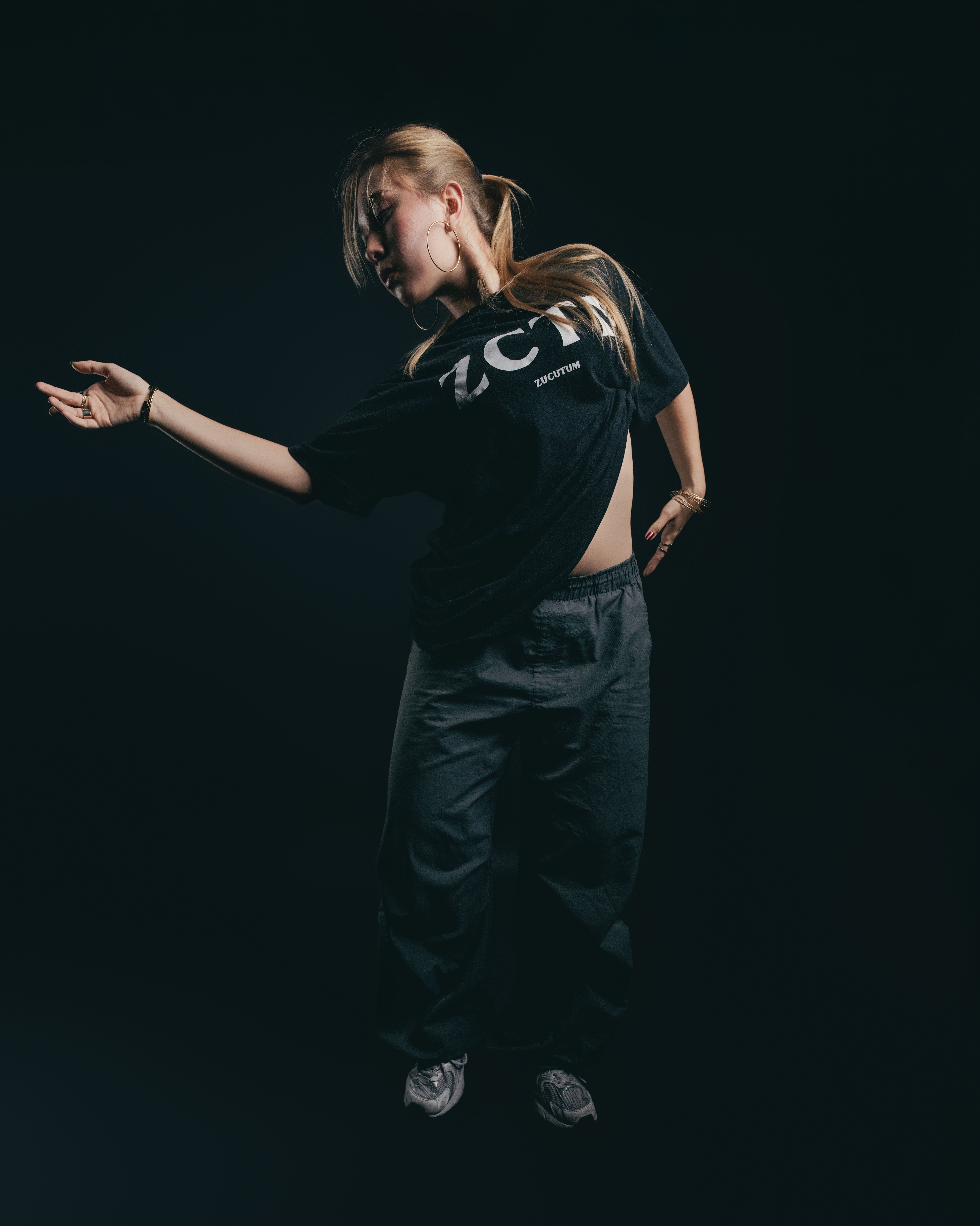 Dynamic Dance Pose Against Dark Background · Free Stock Photo