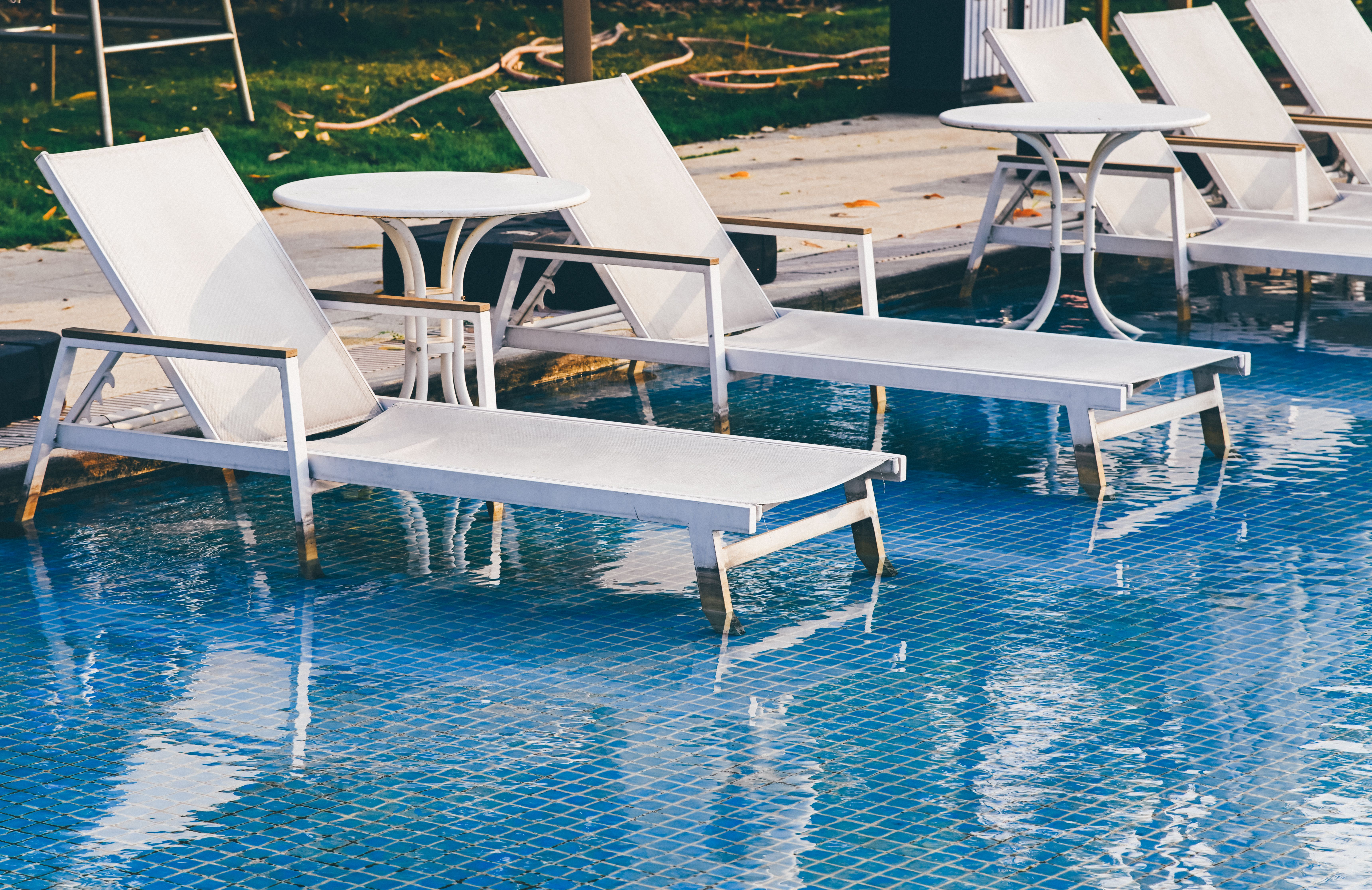 Luxury Poolside Loungers by a Sunny Outdoor Pool · Free Stock Photo
