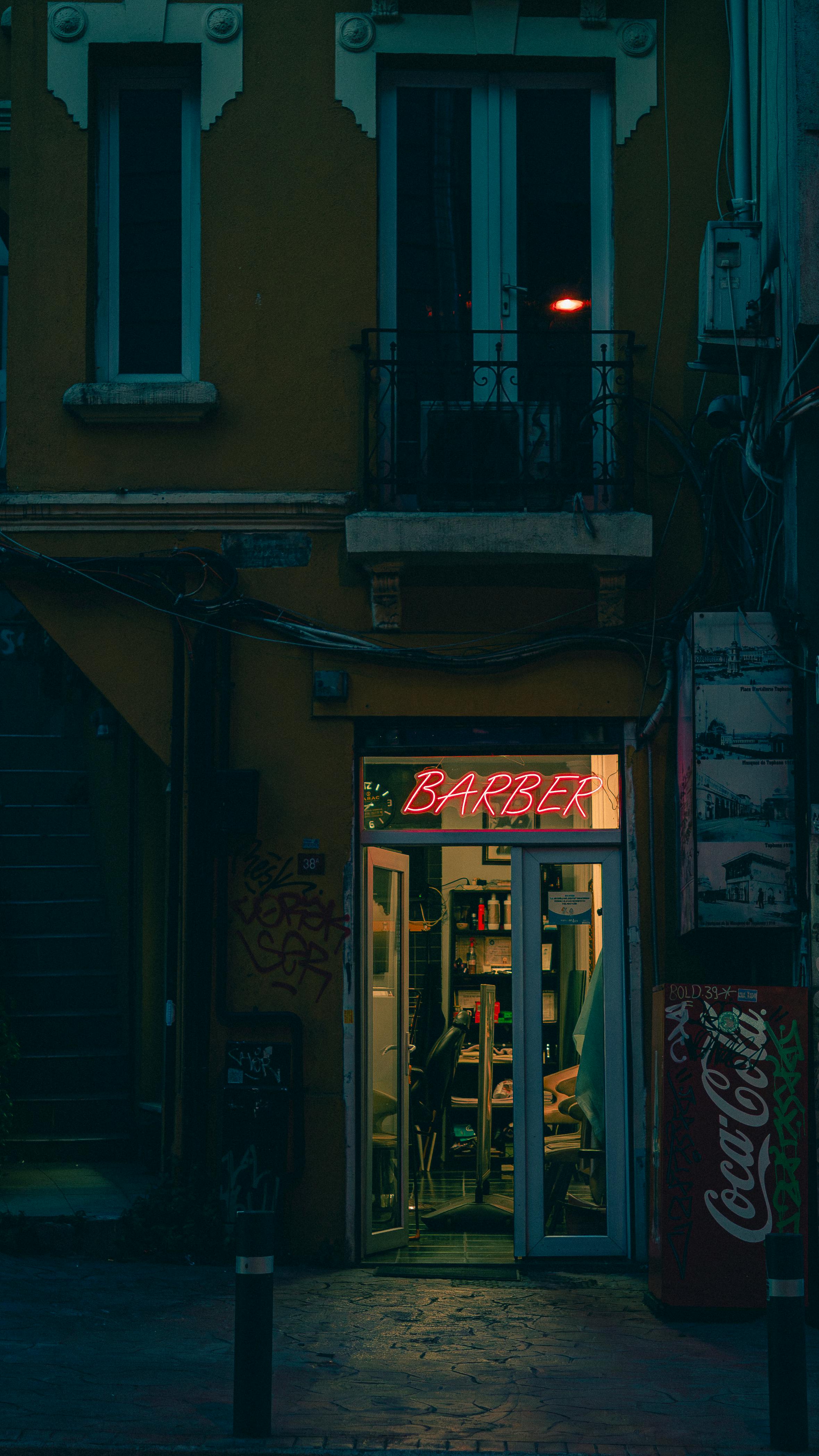 Cozy Nighttime Barber Shop Front View · Free Stock Photo