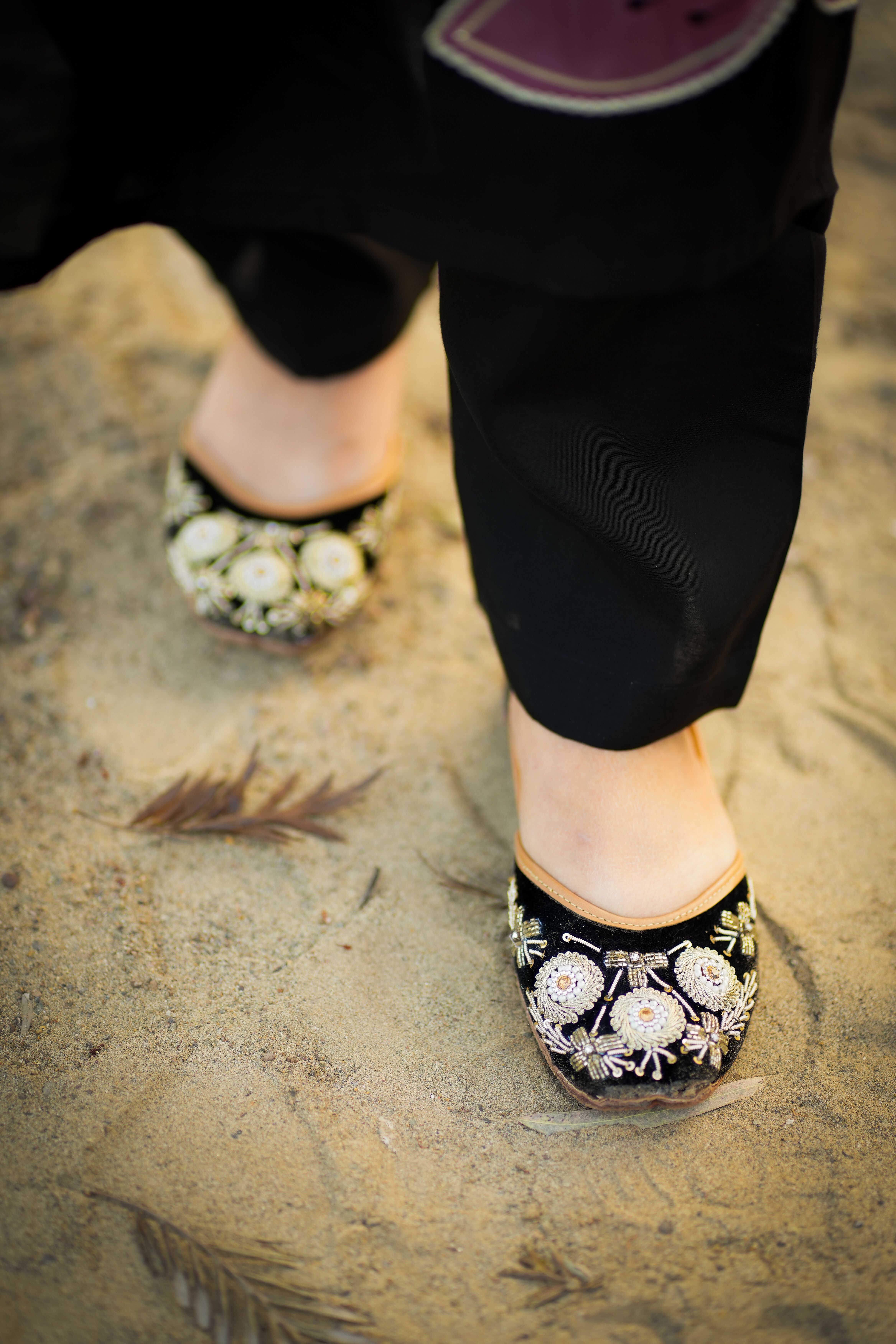 Decorative Footwear on Sandy Surface Close-up · Free Stock Photo