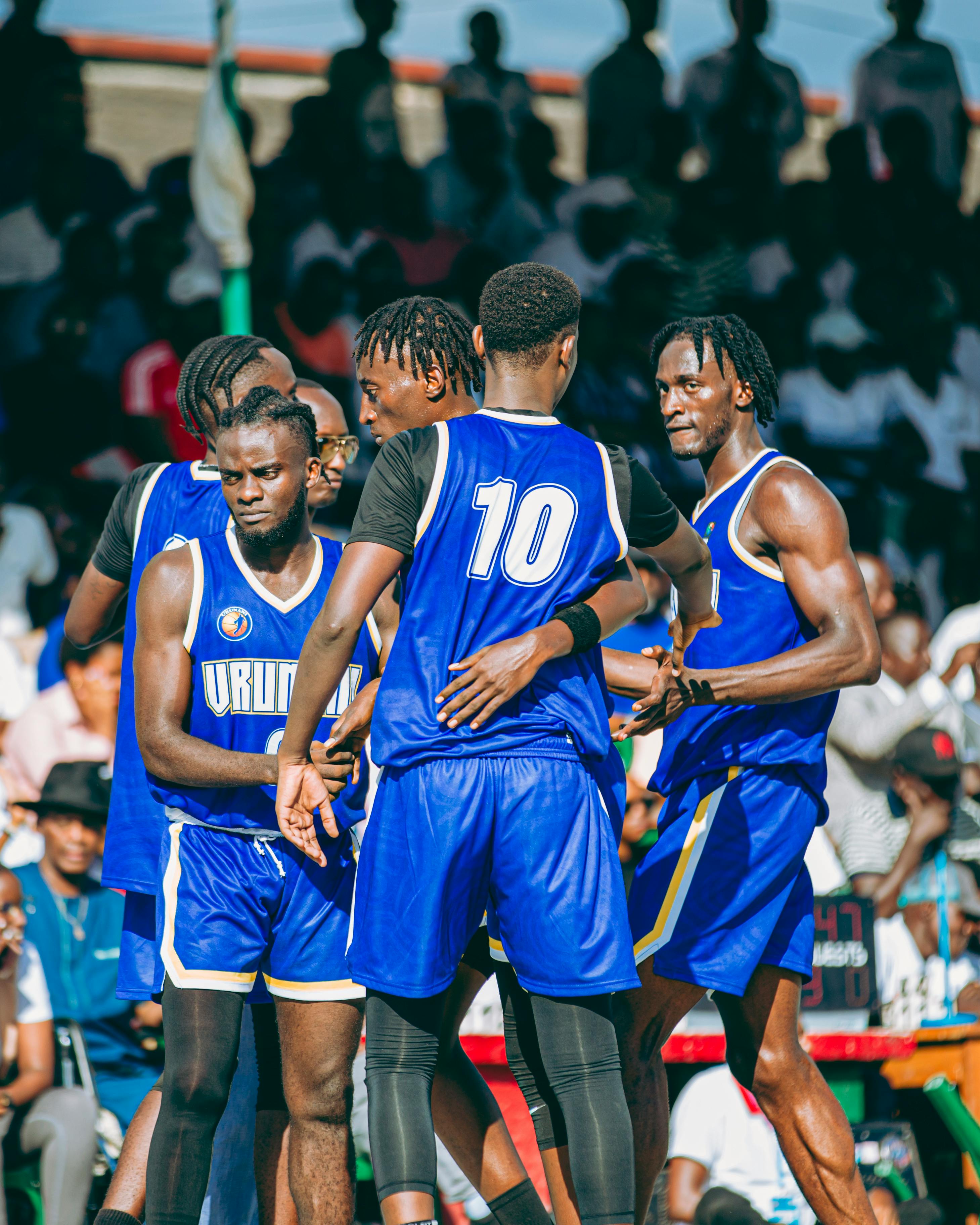 Basketball team stacking hands together · Free Stock Photo
