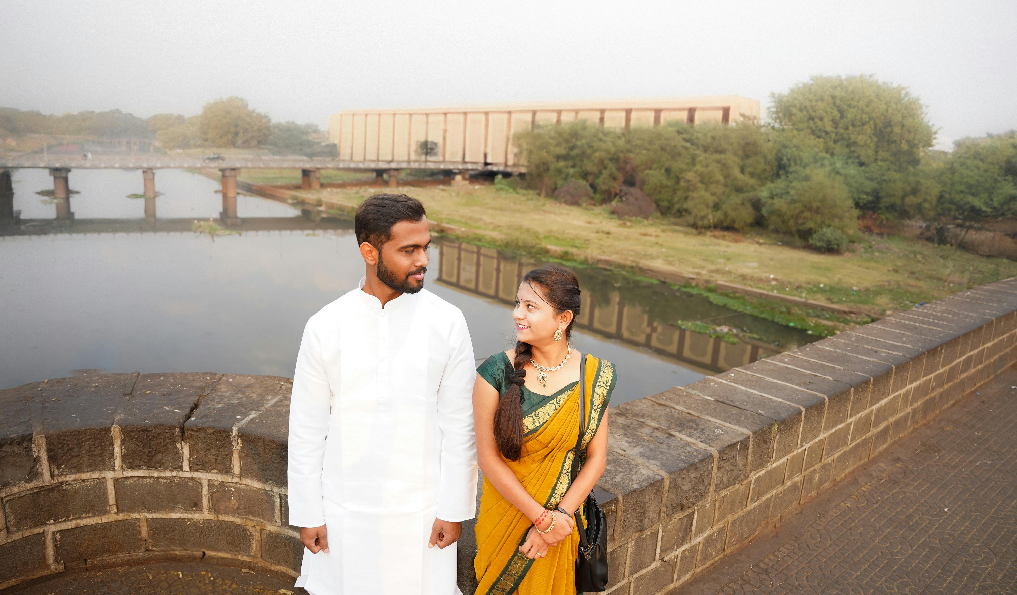 Charming Couple Enjoying Riverside View in Pune · Free Stock Photo