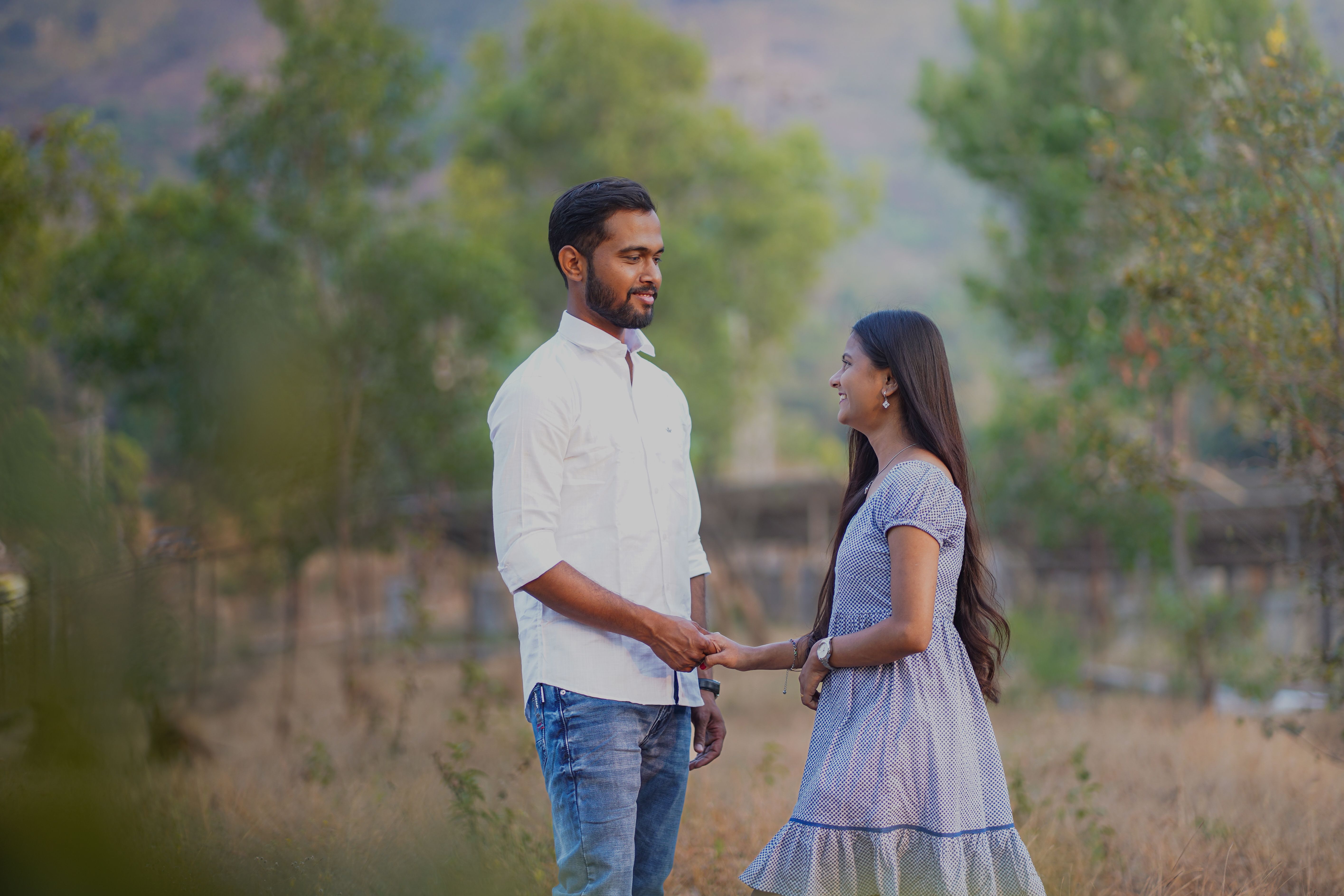 Romantic Couple Holding Hands in Nature · Free Stock Photo