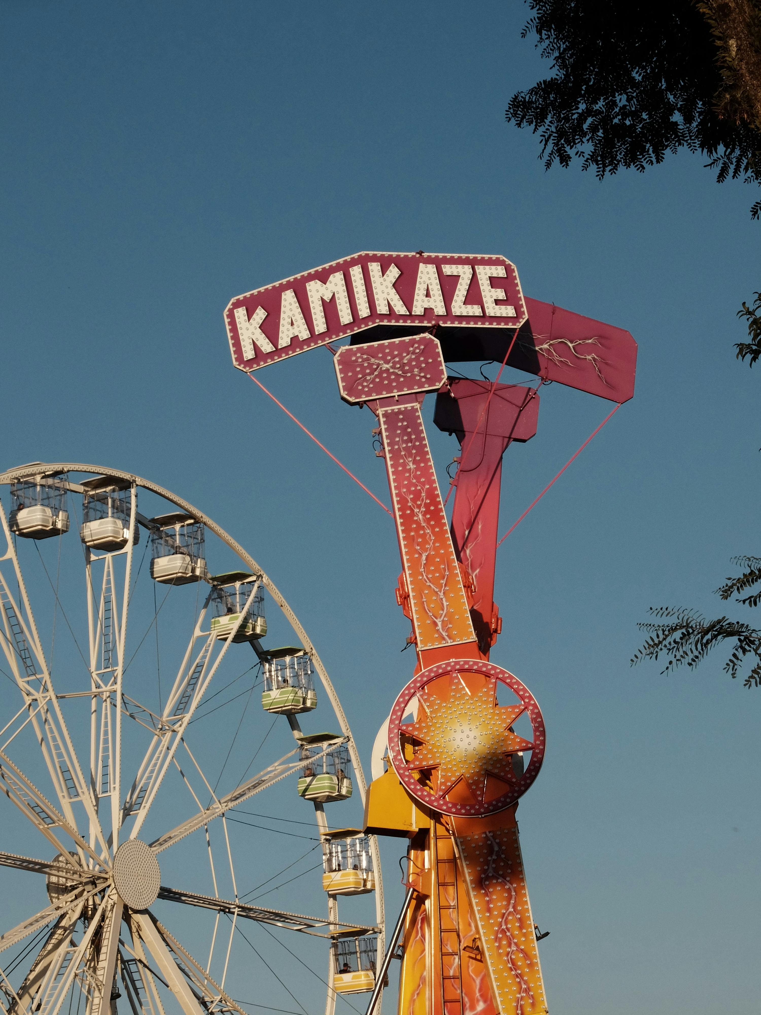 Kamikaze Ride with Ferris Wheel at Fun Fair · Free Stock Photo