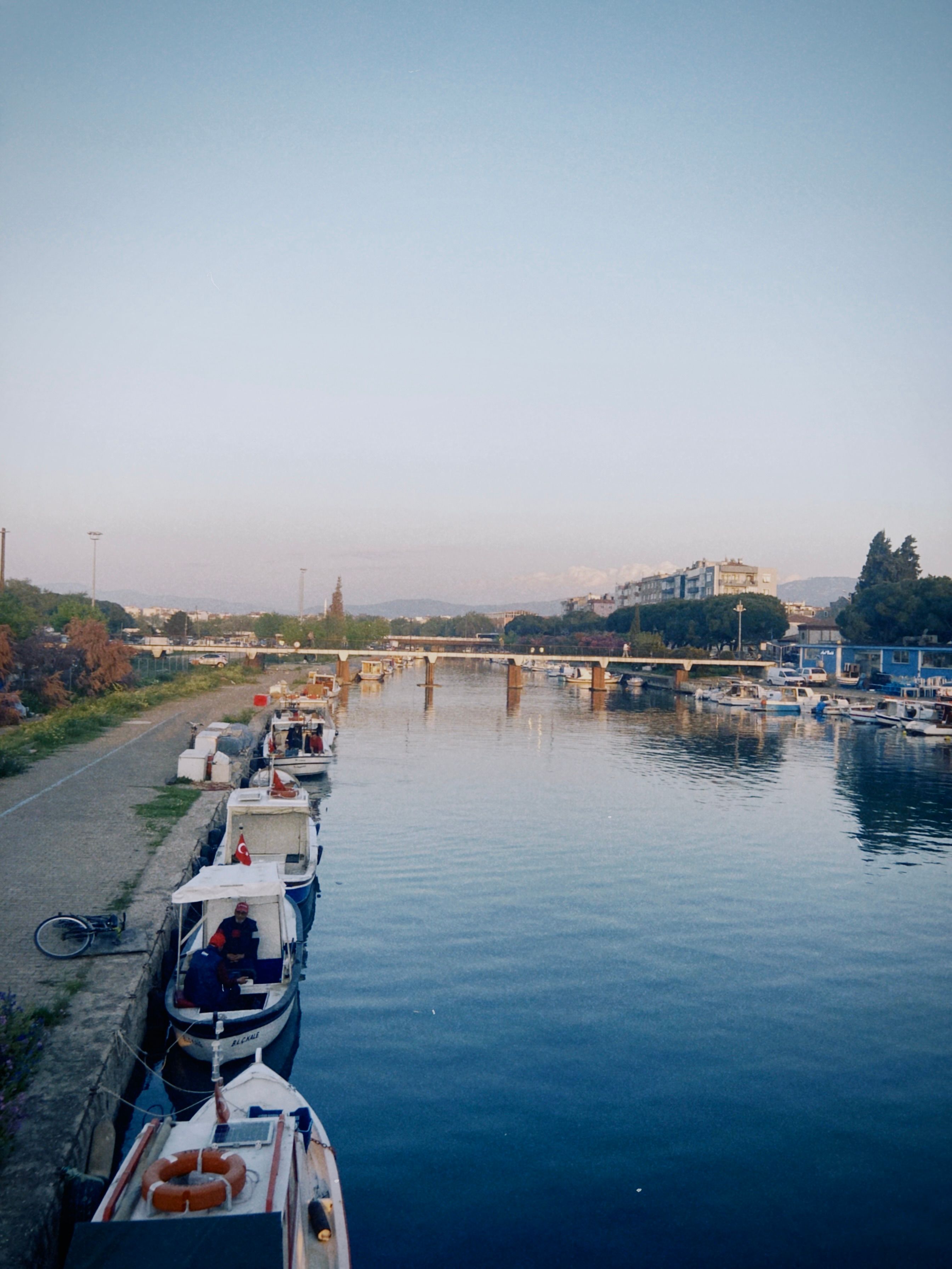 Scenic Riverside with Boats in Tranquil Setting · Free Stock Photo