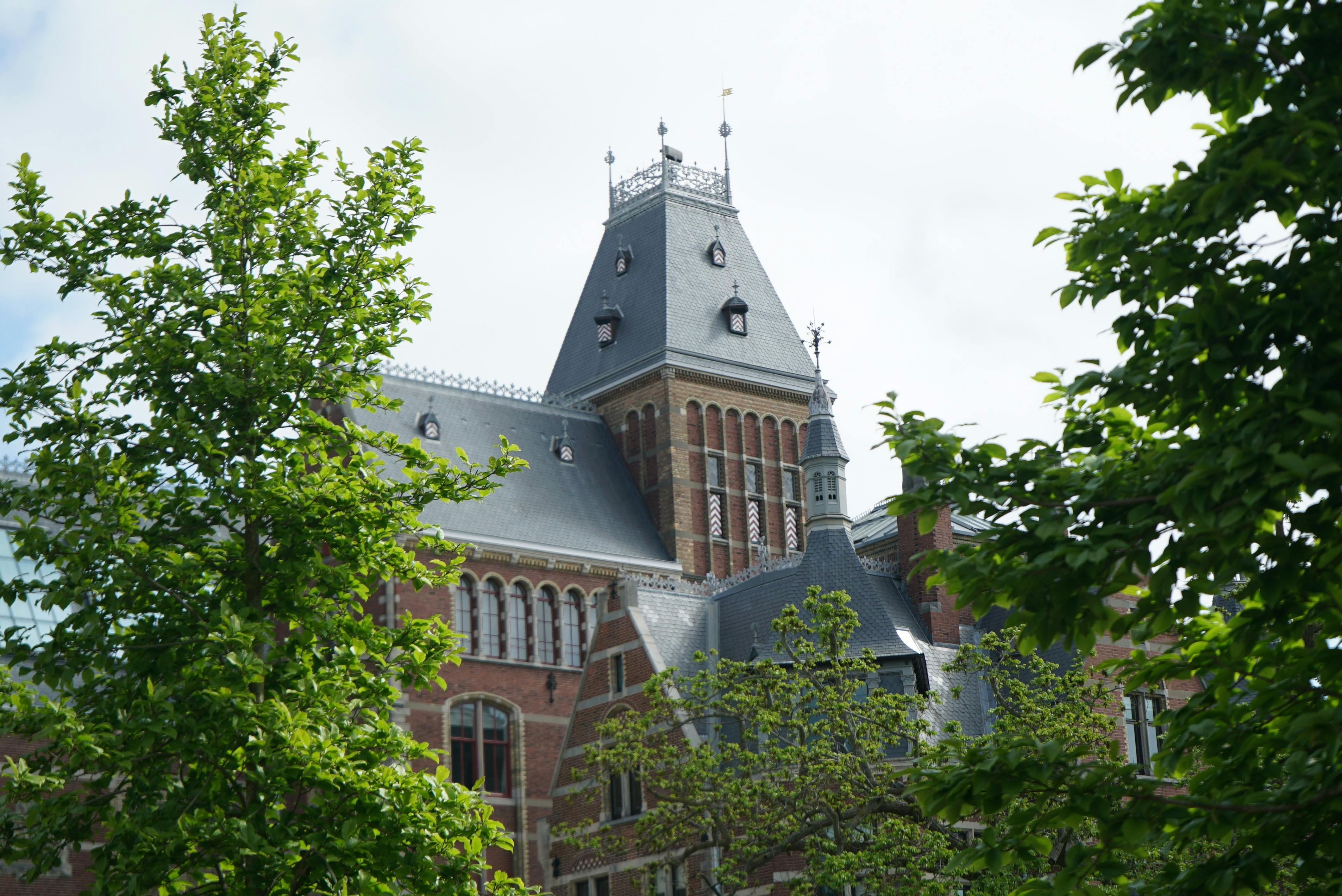 Historic European Brick Building in Greenery · Free Stock Photo