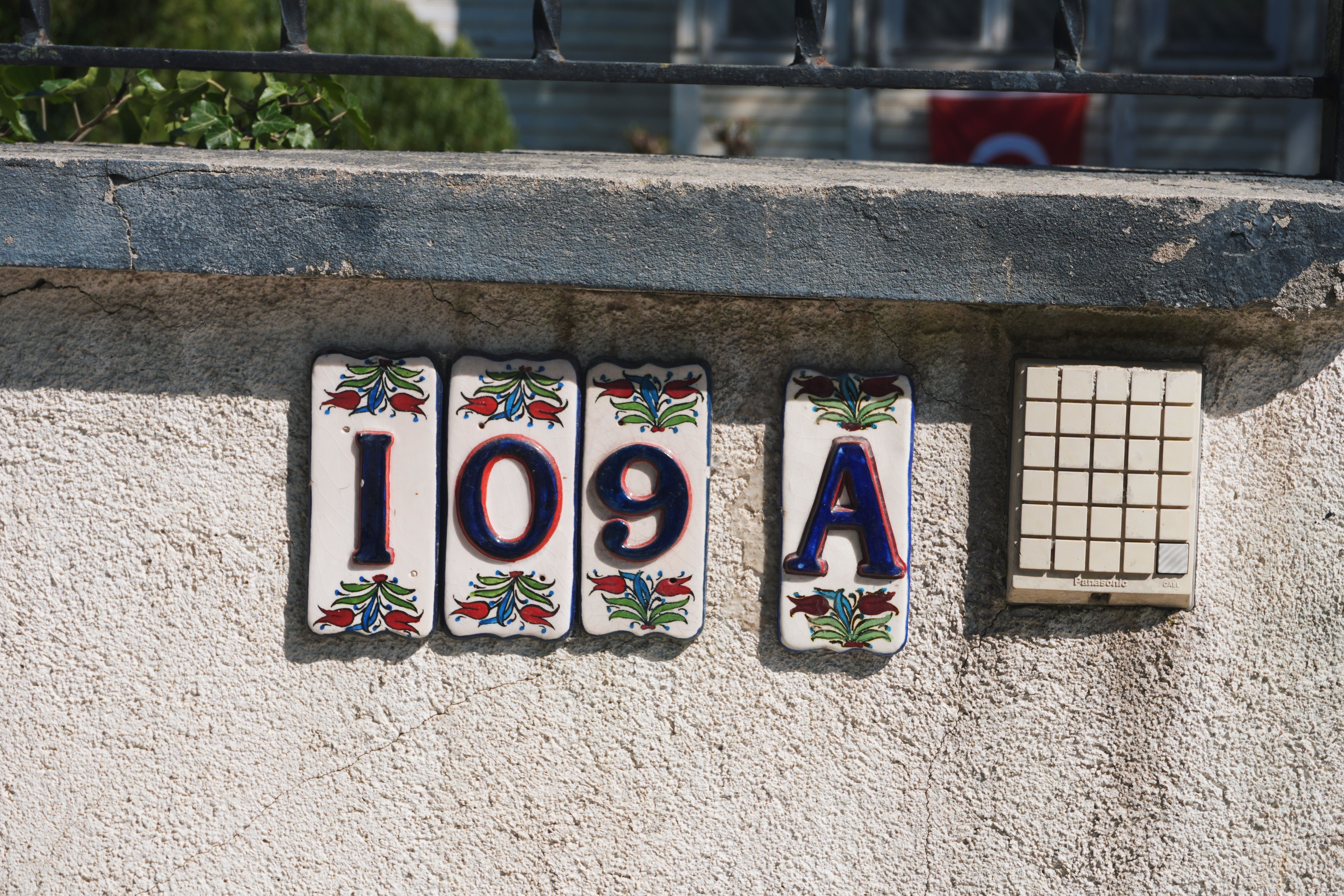 Ceramic House Number Tile in Sunlight · Free Stock Photo