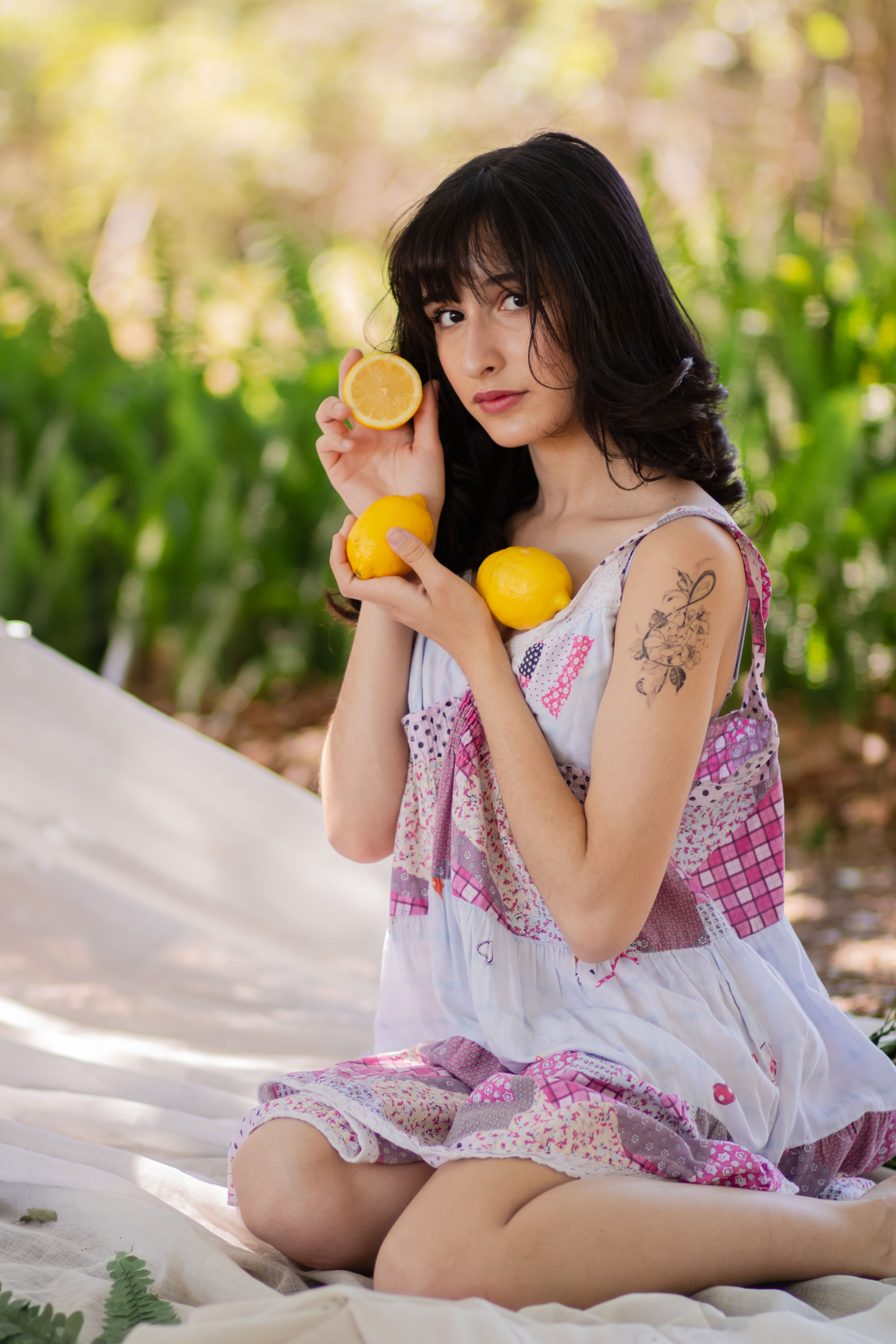 Young Woman with Lemons in a Garden Setting · Free Stock Photo