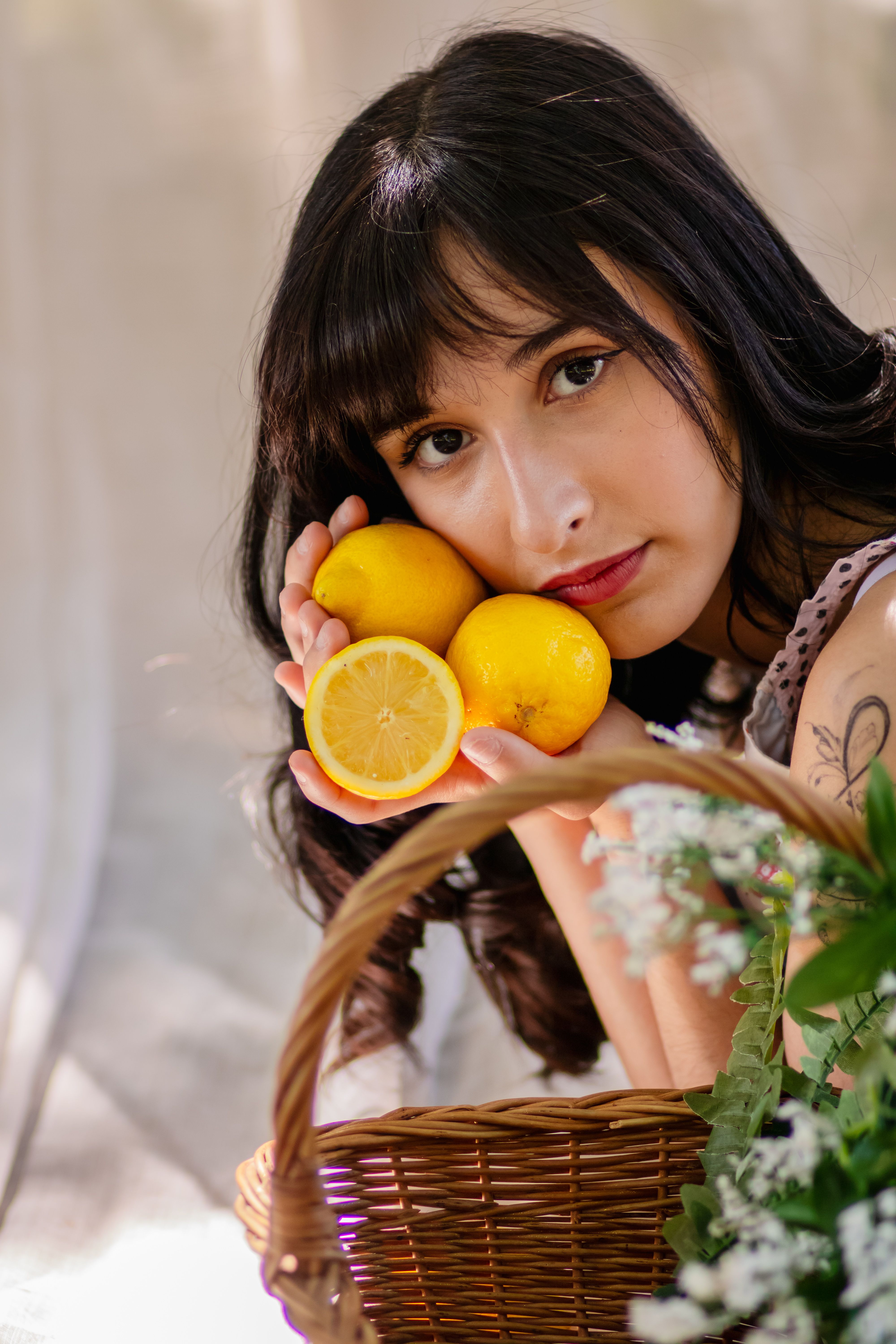Young Woman with Lemons and Basket Outdoors · Free Stock Photo