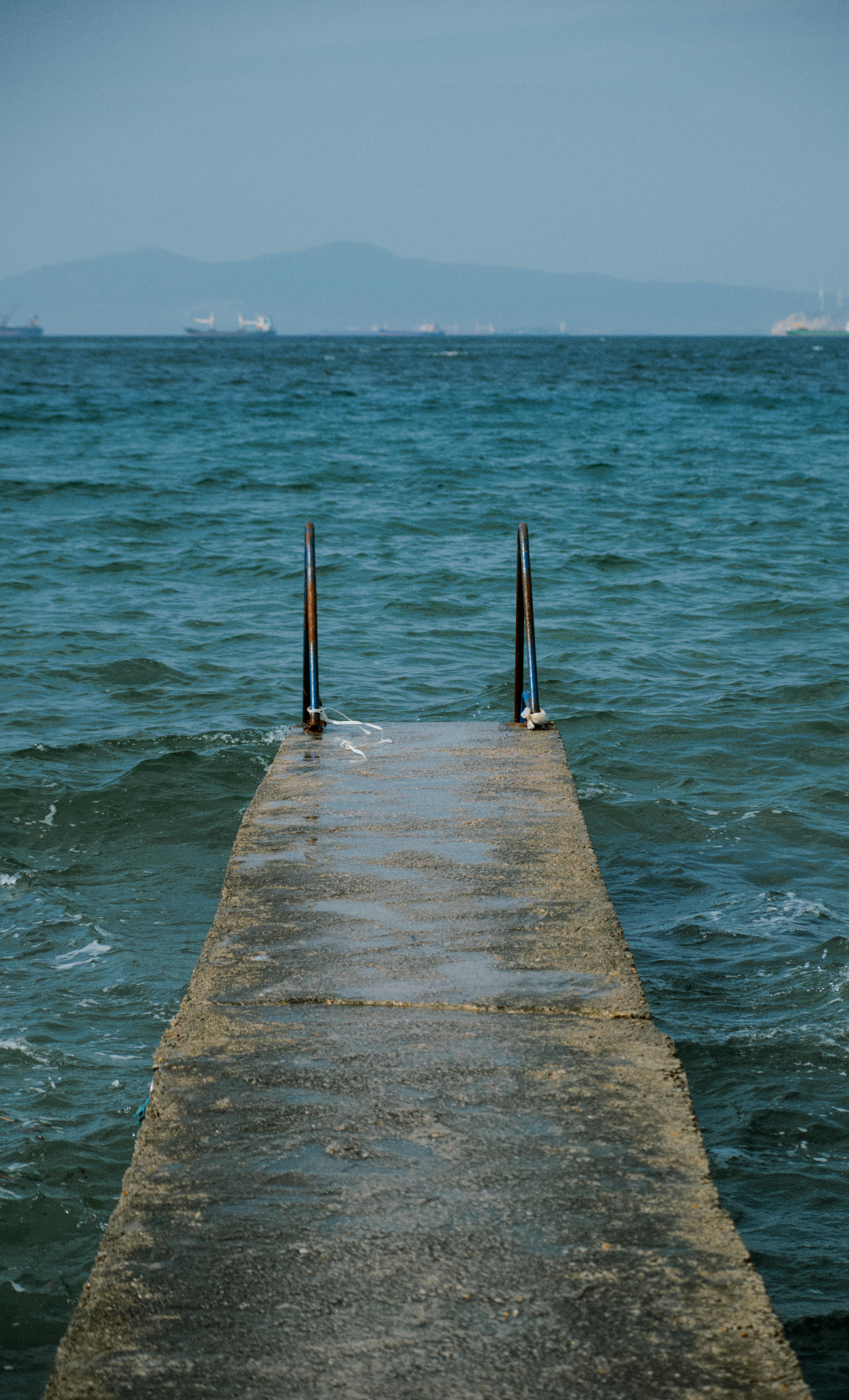 Tranquil Jetty Extending into the Blue Ocean · Free Stock Photo