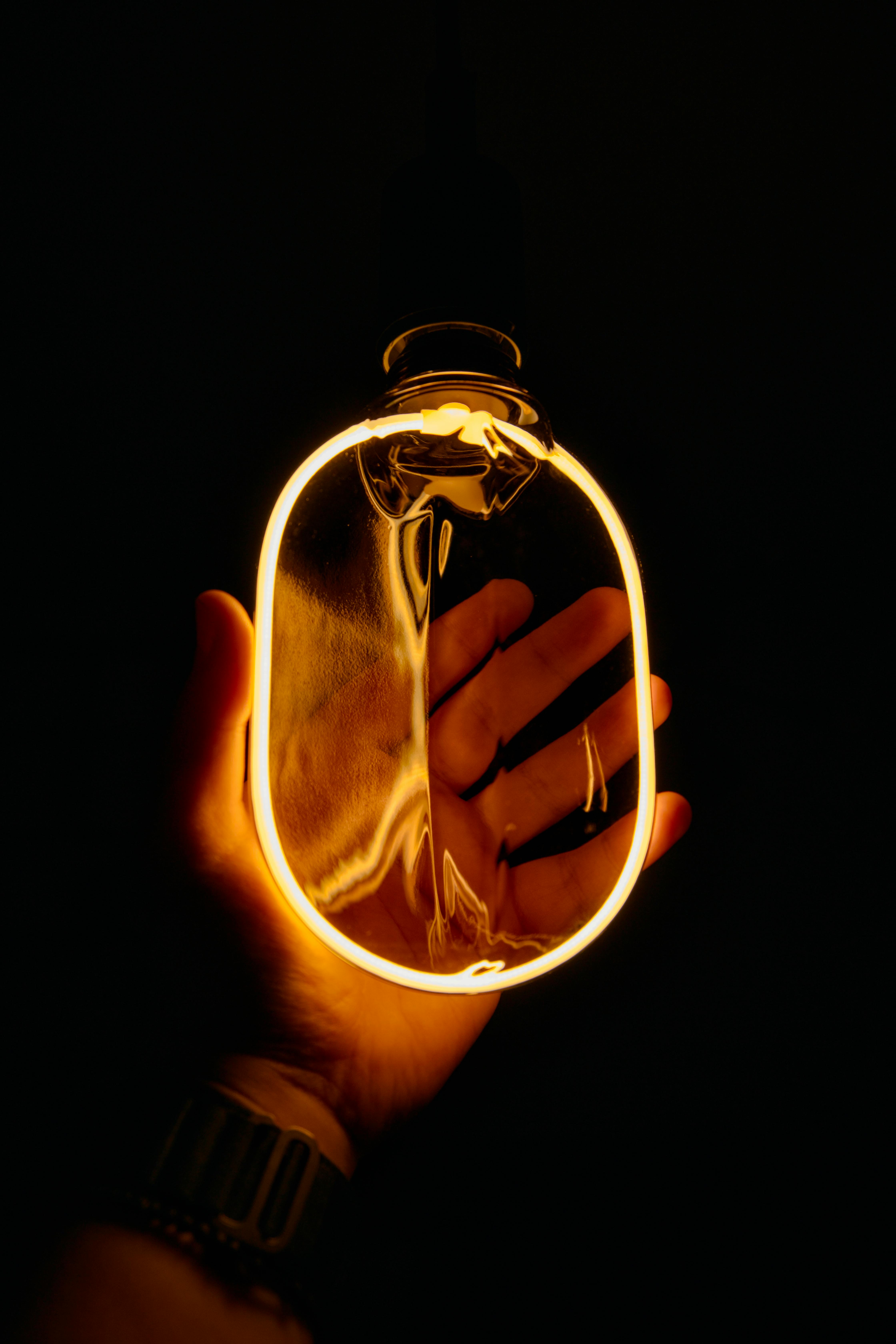 Warm Ambient Lighting with Handheld Bulb · Free Stock Photo