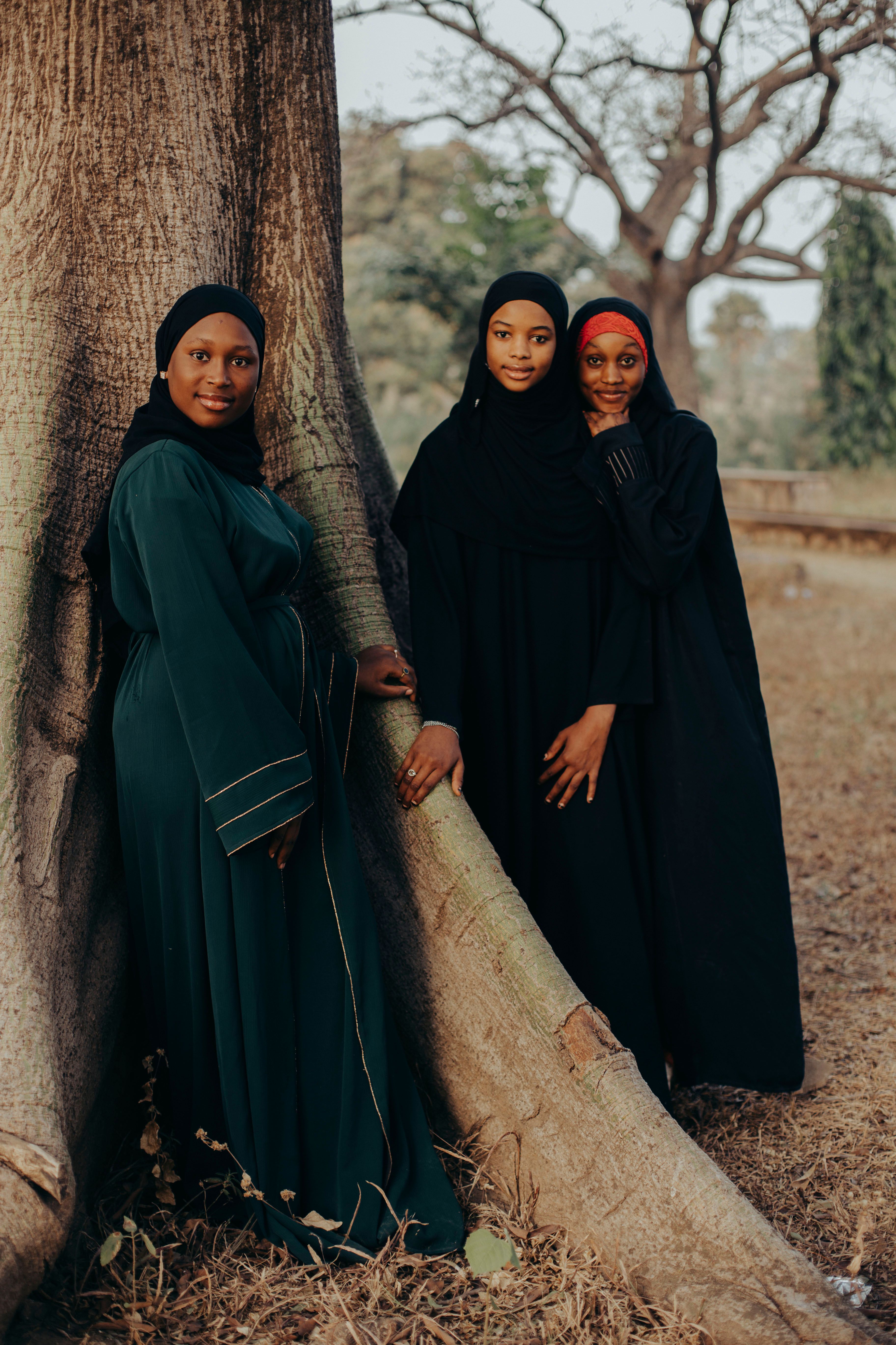 Three Women in Traditional Dresses by Tree · Free Stock Photo