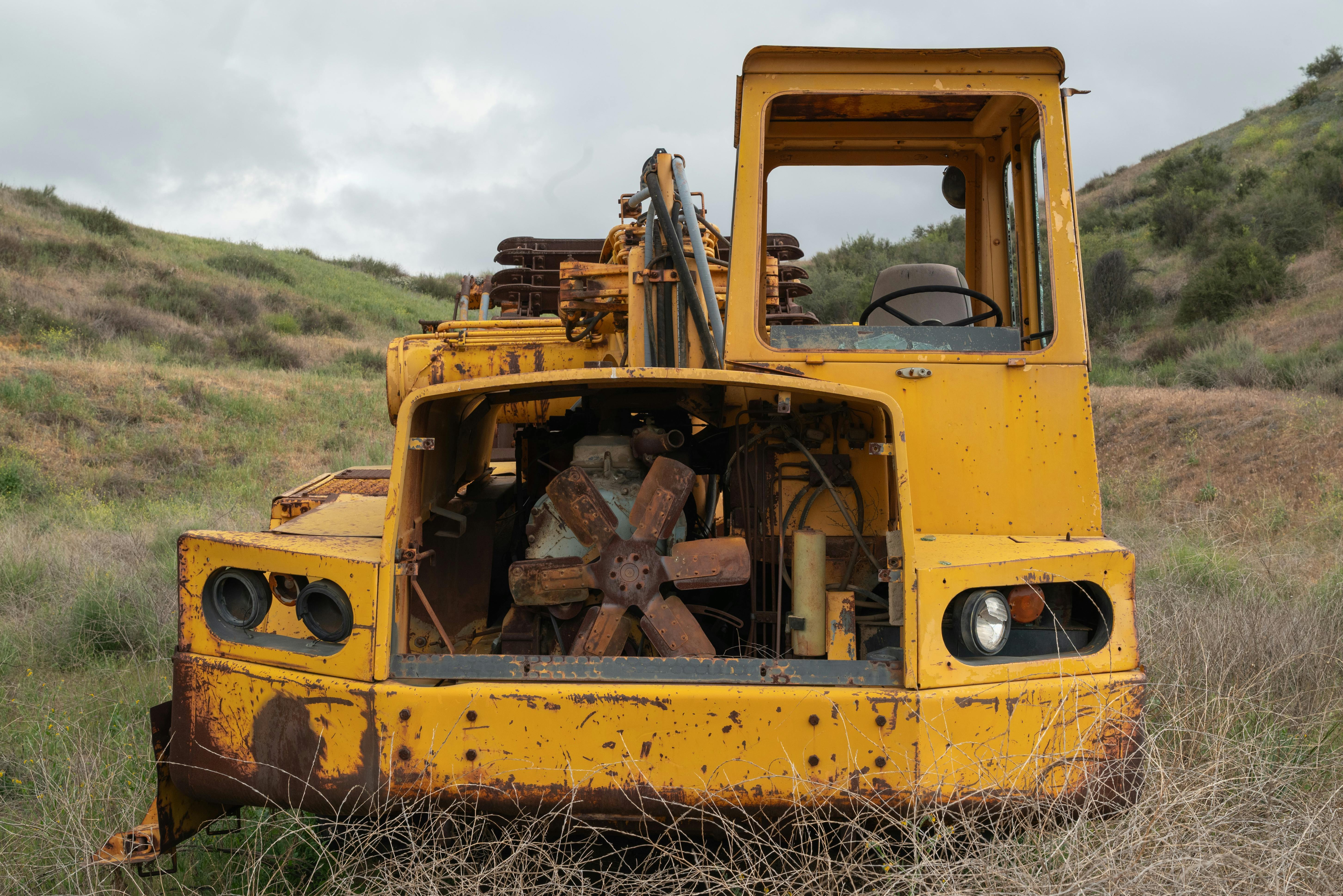 Rusty Vintage Yellow Bulldozer in a Field · Free Stock Photo