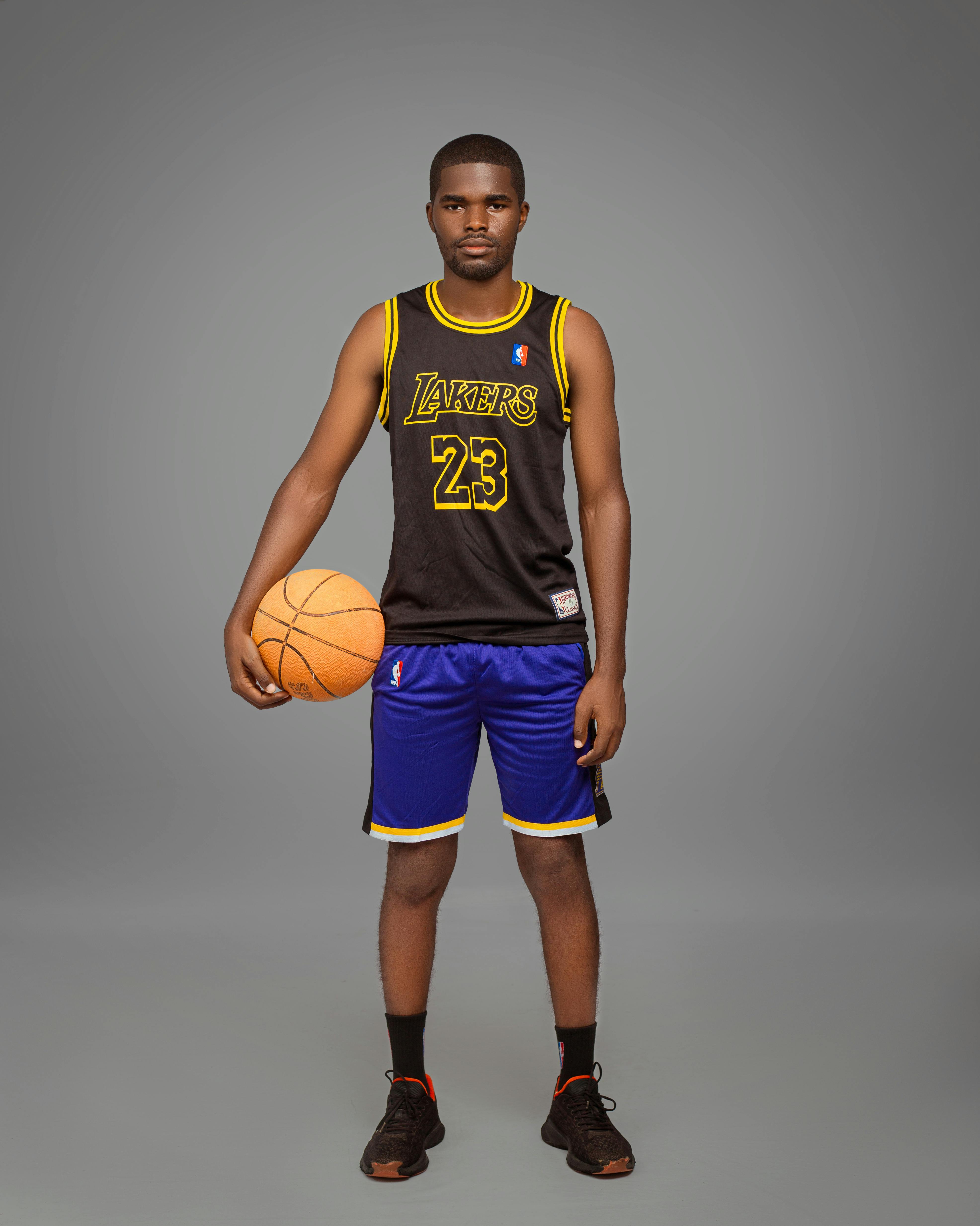 Young Male Basketball Player Posing with Ball · Free Stock Photo