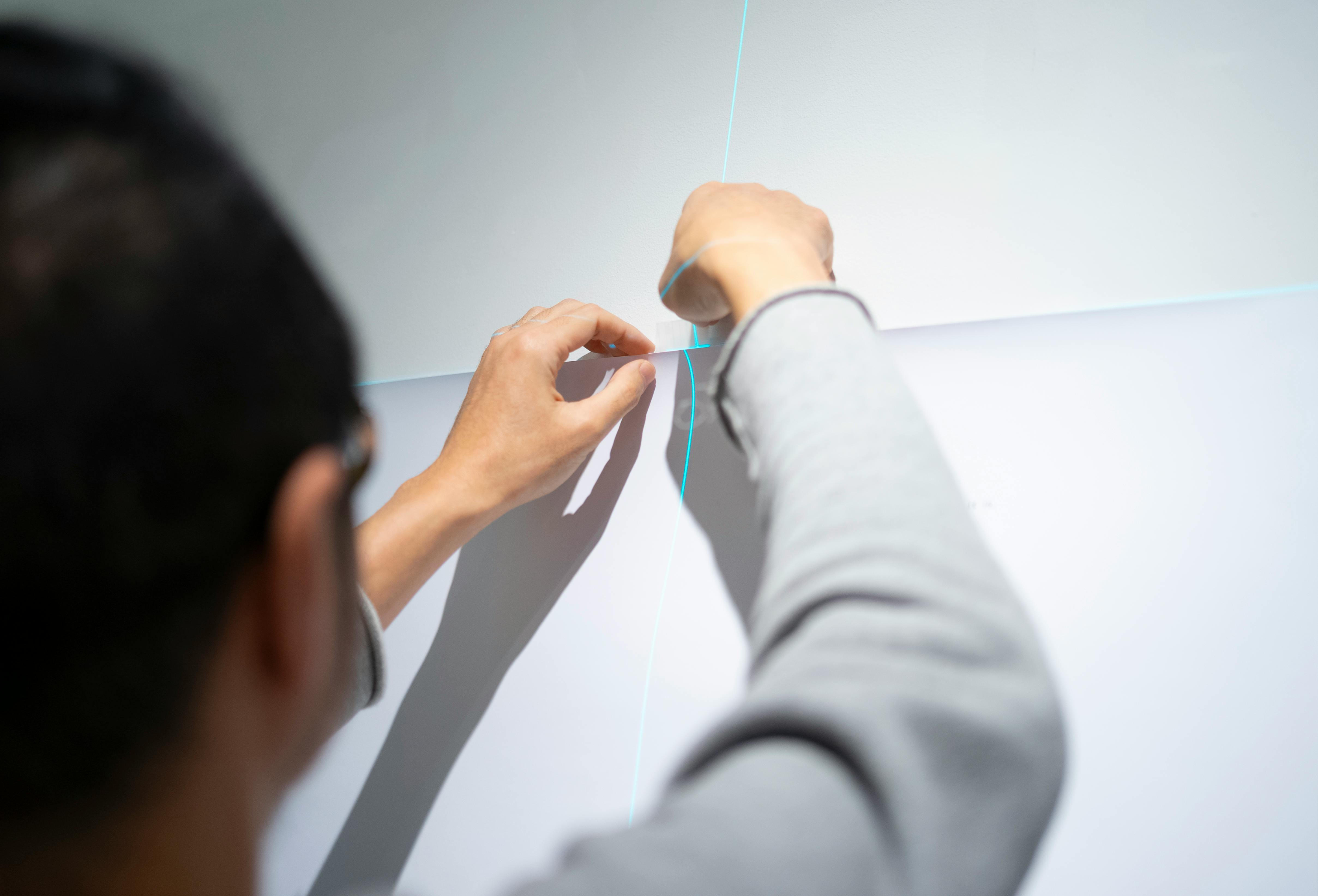 Person Adjusting Projector Alignment with Precision · Free Stock Photo
