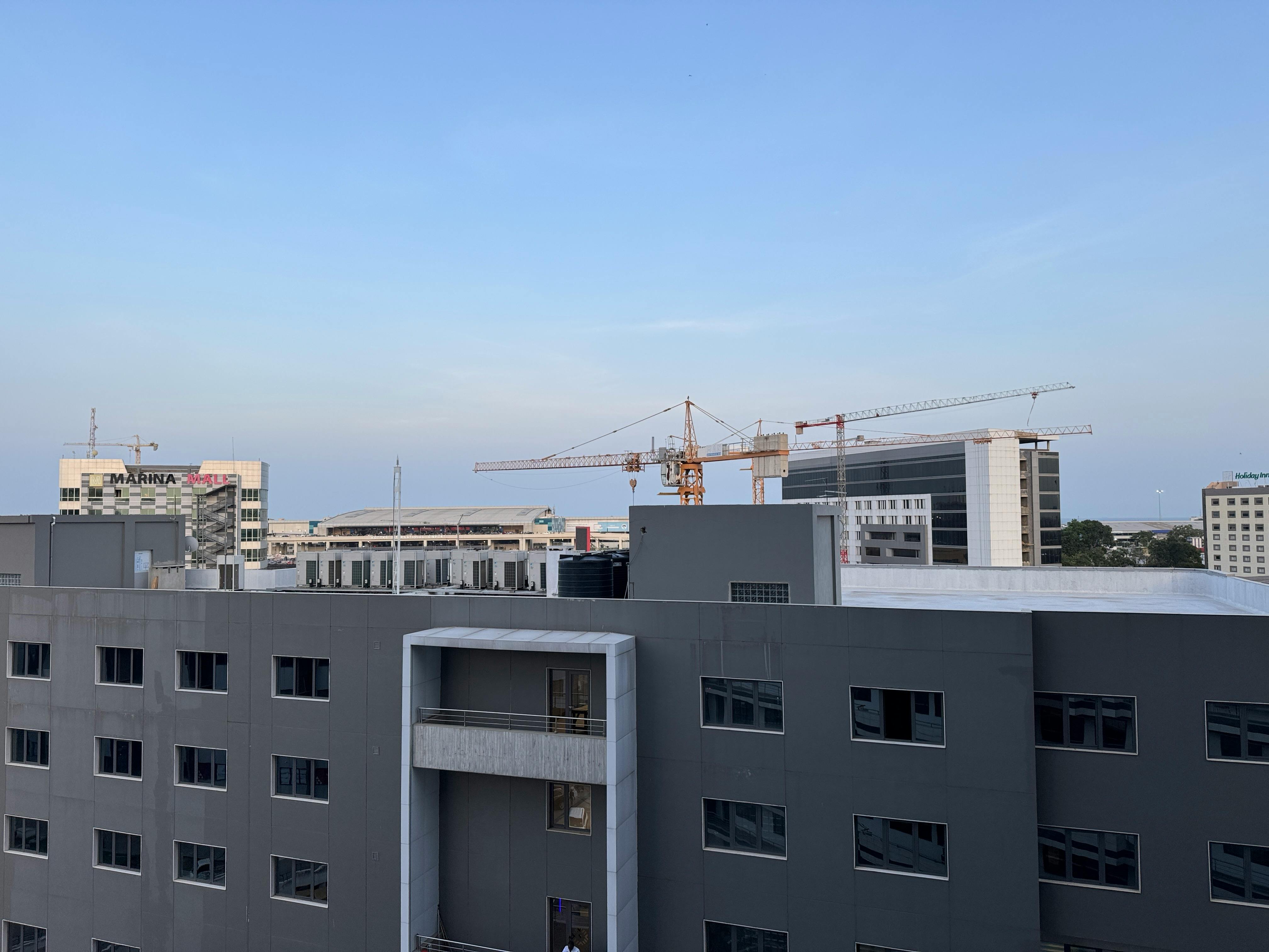 Modern Cityscape of Accra with Construction Cranes · Free Stock Photo