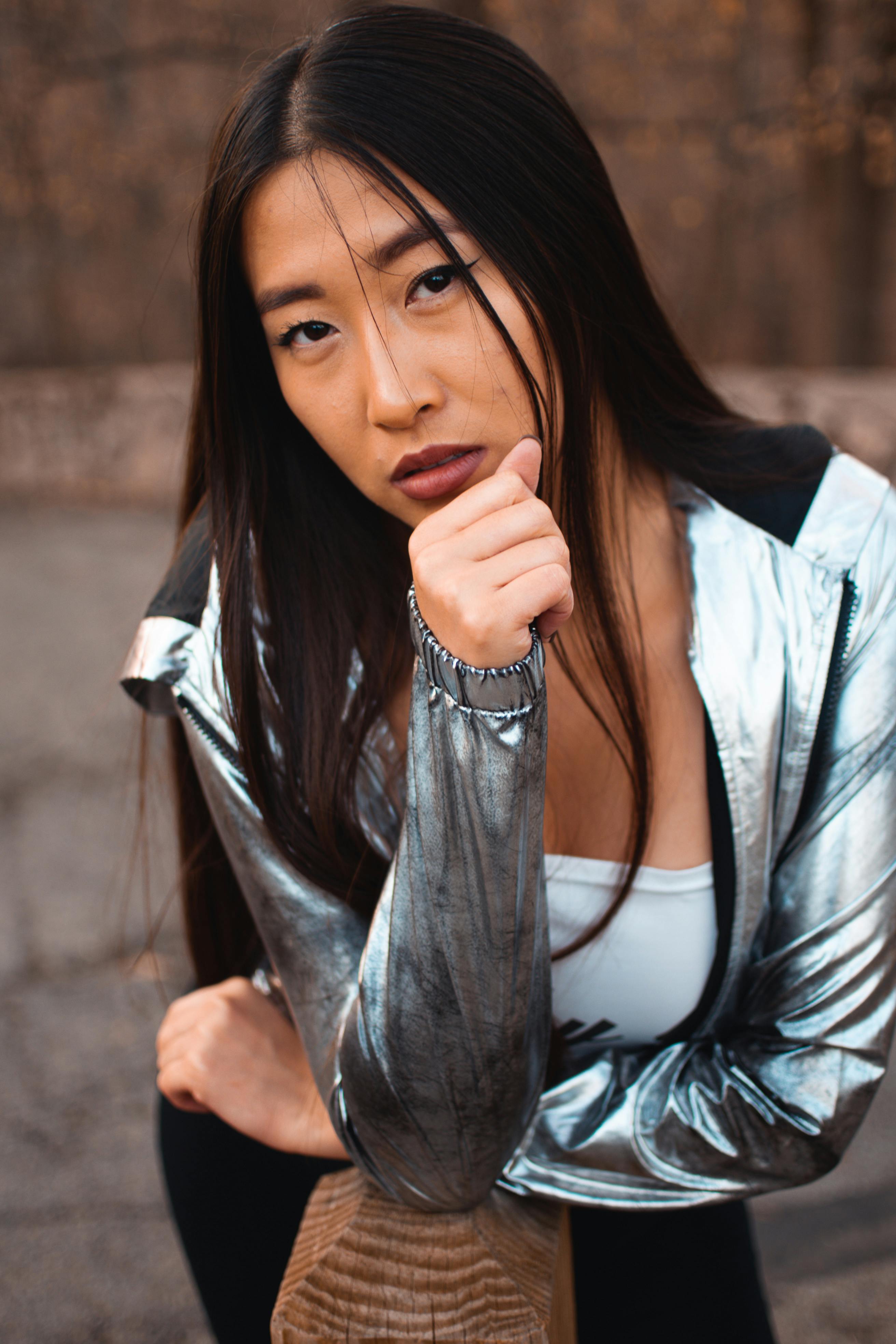 Close-up OF A Woman Wearing Gray Metallic Zip-up Jacket · Free Stock Photo