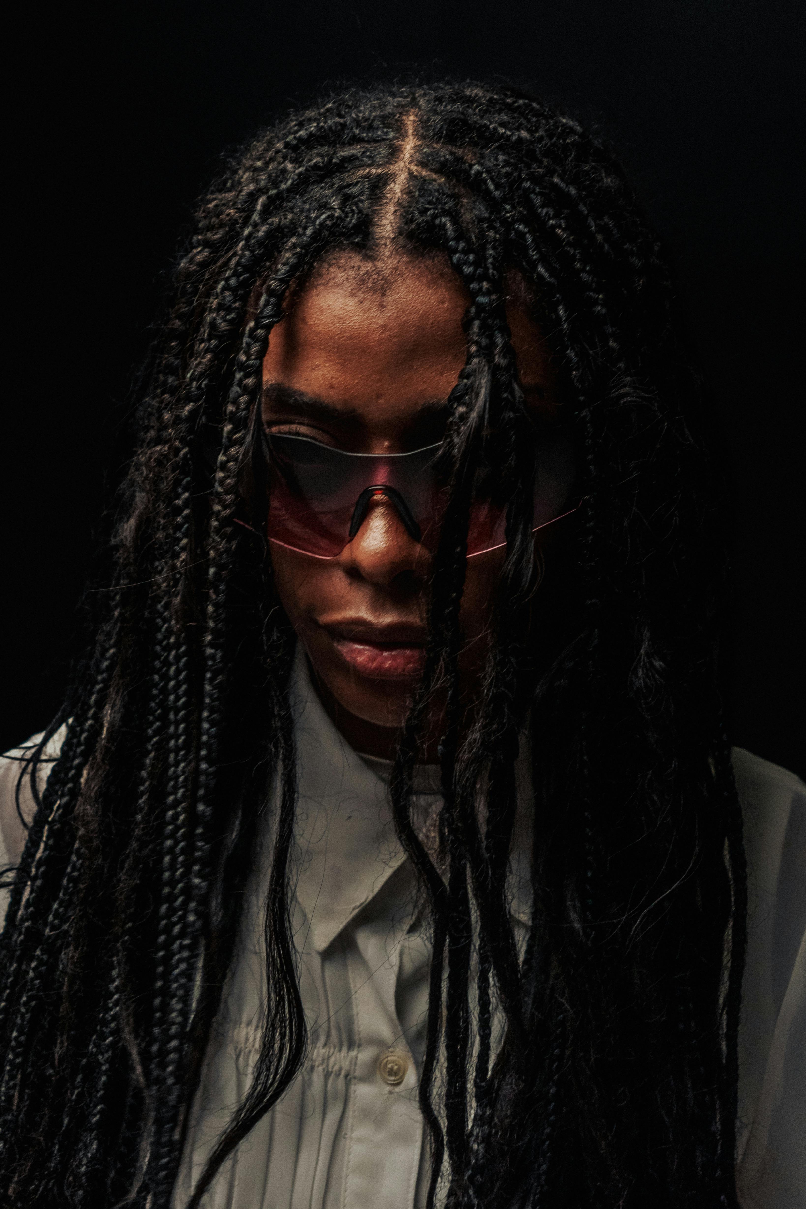 Stylish Individual Wearing Sunglasses in Low Light · Free Stock Photo