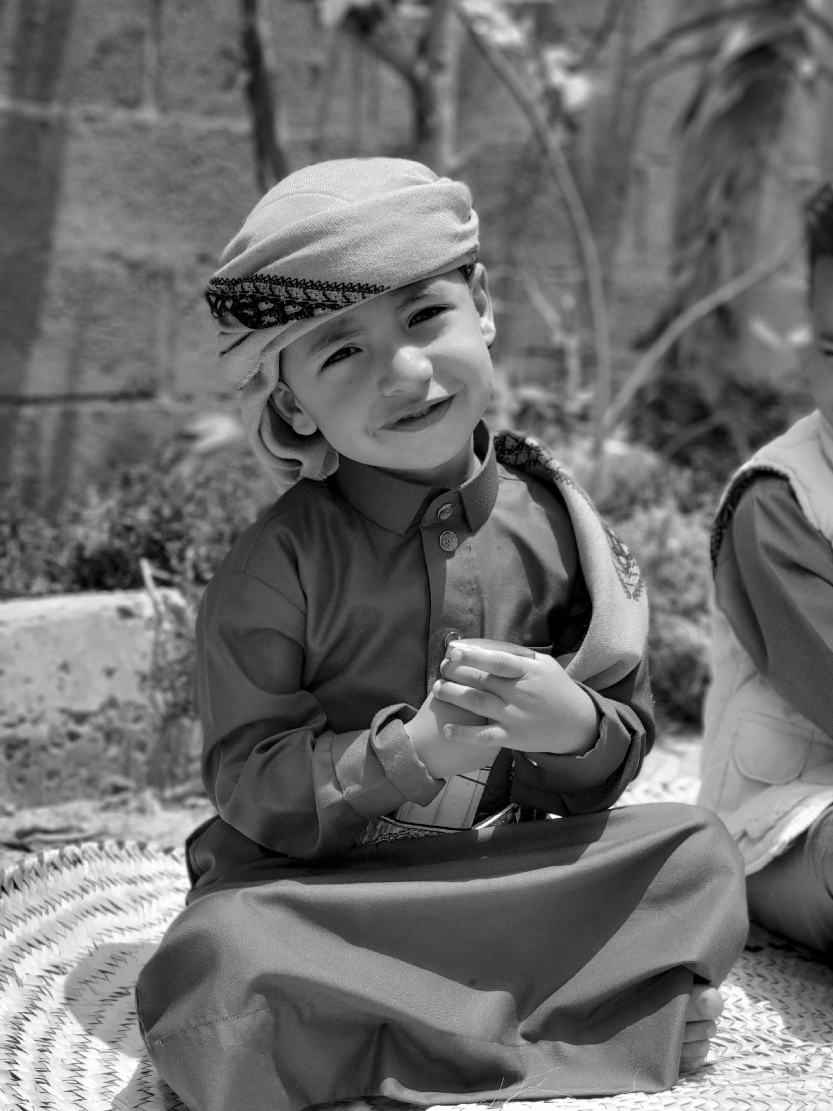 Young Boy in Traditional Yemeni Dress Smiling · Free Stock Photo