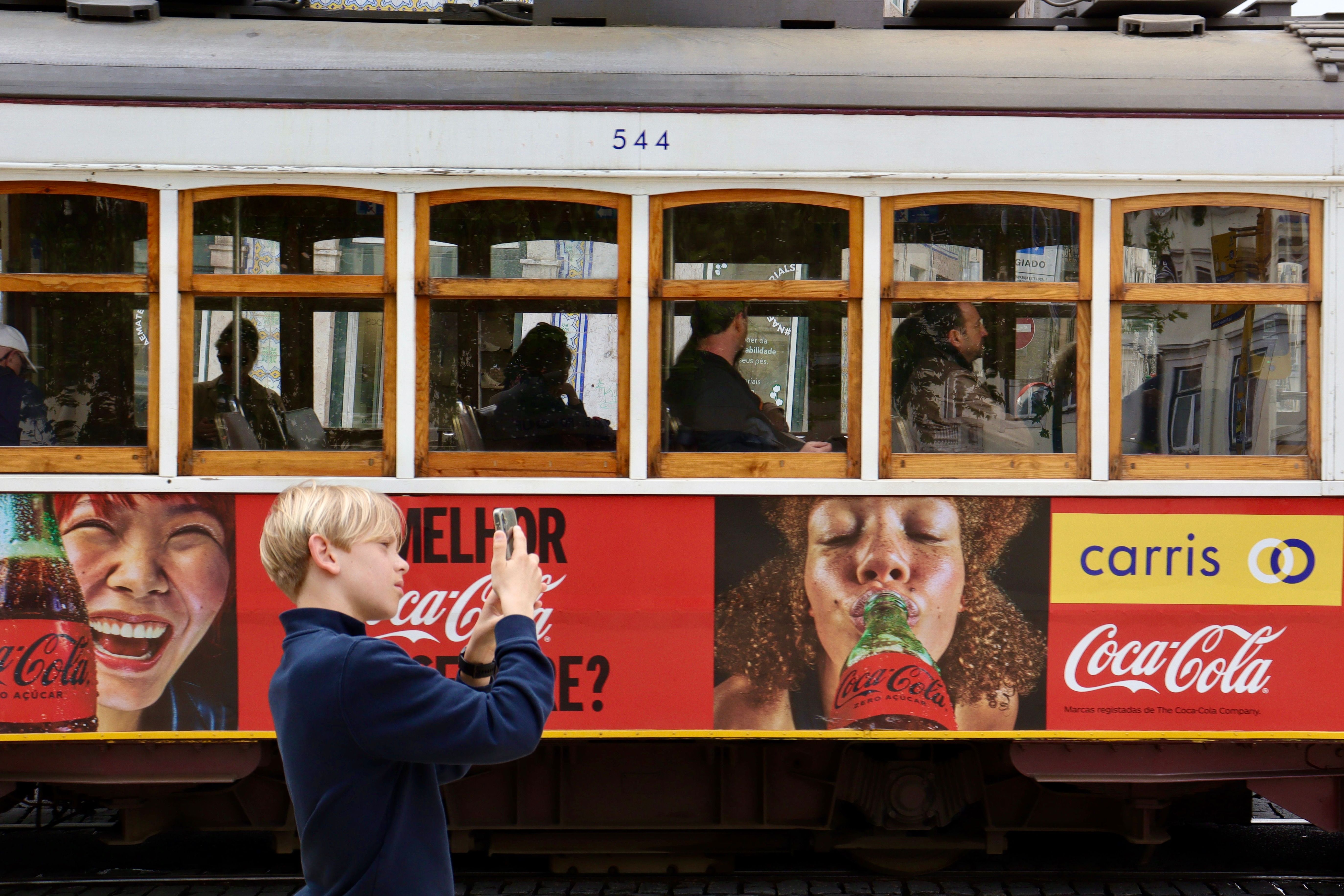 Young Photographer Captures Iconic Lisbon Tram · Free Stock Photo