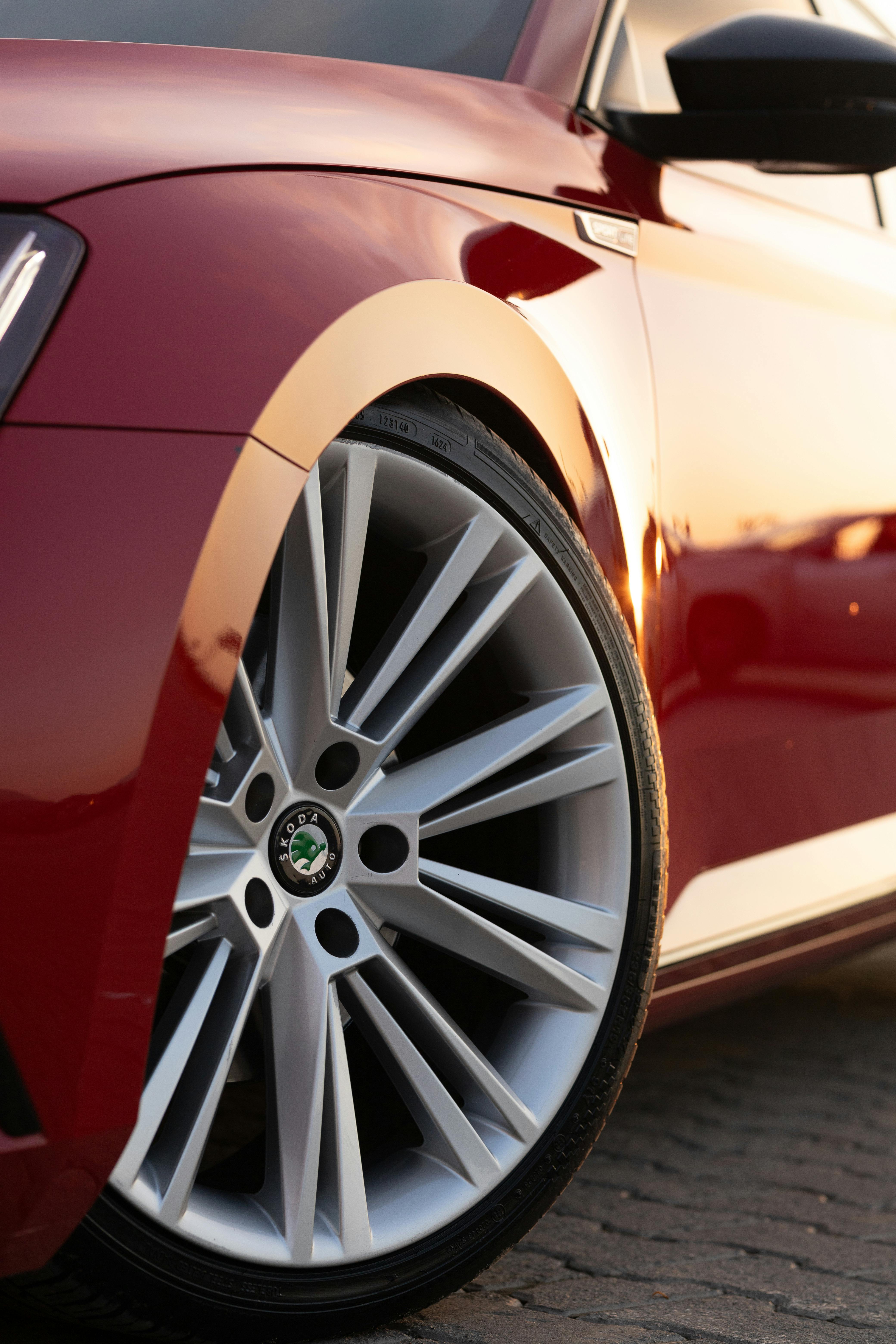 Close-Up of Red Car Wheel at Sunset · Free Stock Photo