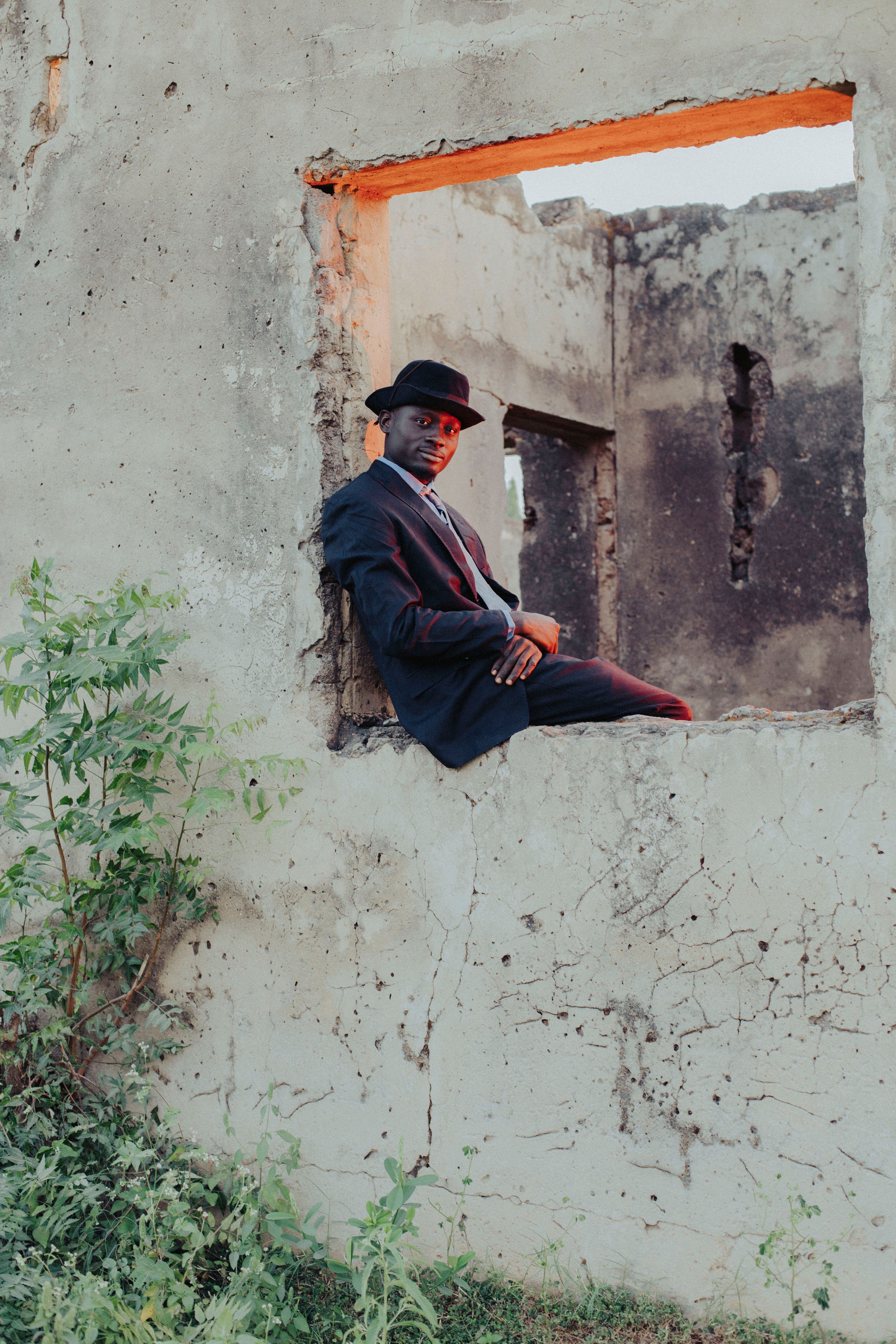 Stylish Man in Suit Sitting in Abandoned Building · Free Stock Photo