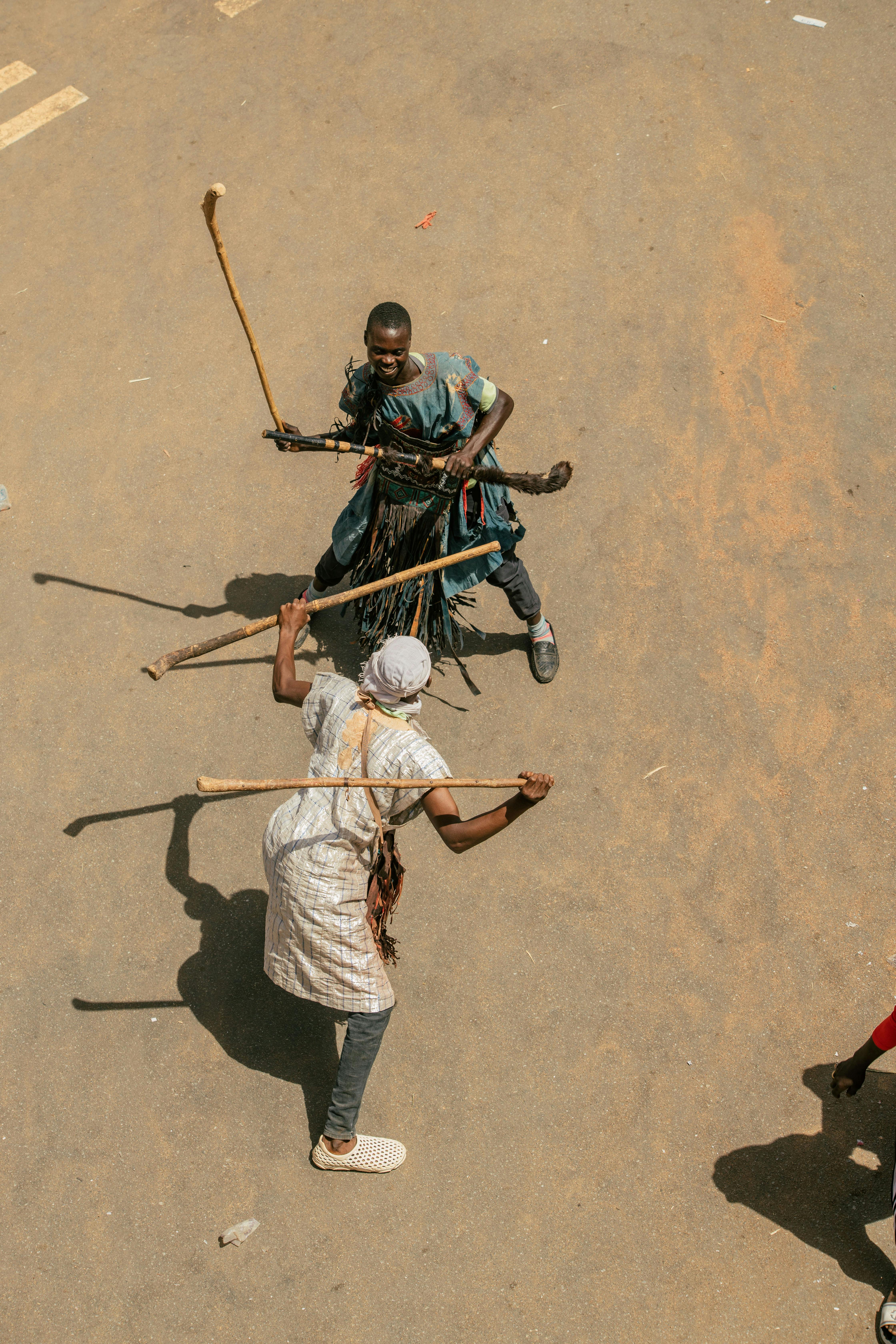 Traditional Stick Fighting in Open Arena · Free Stock Photo