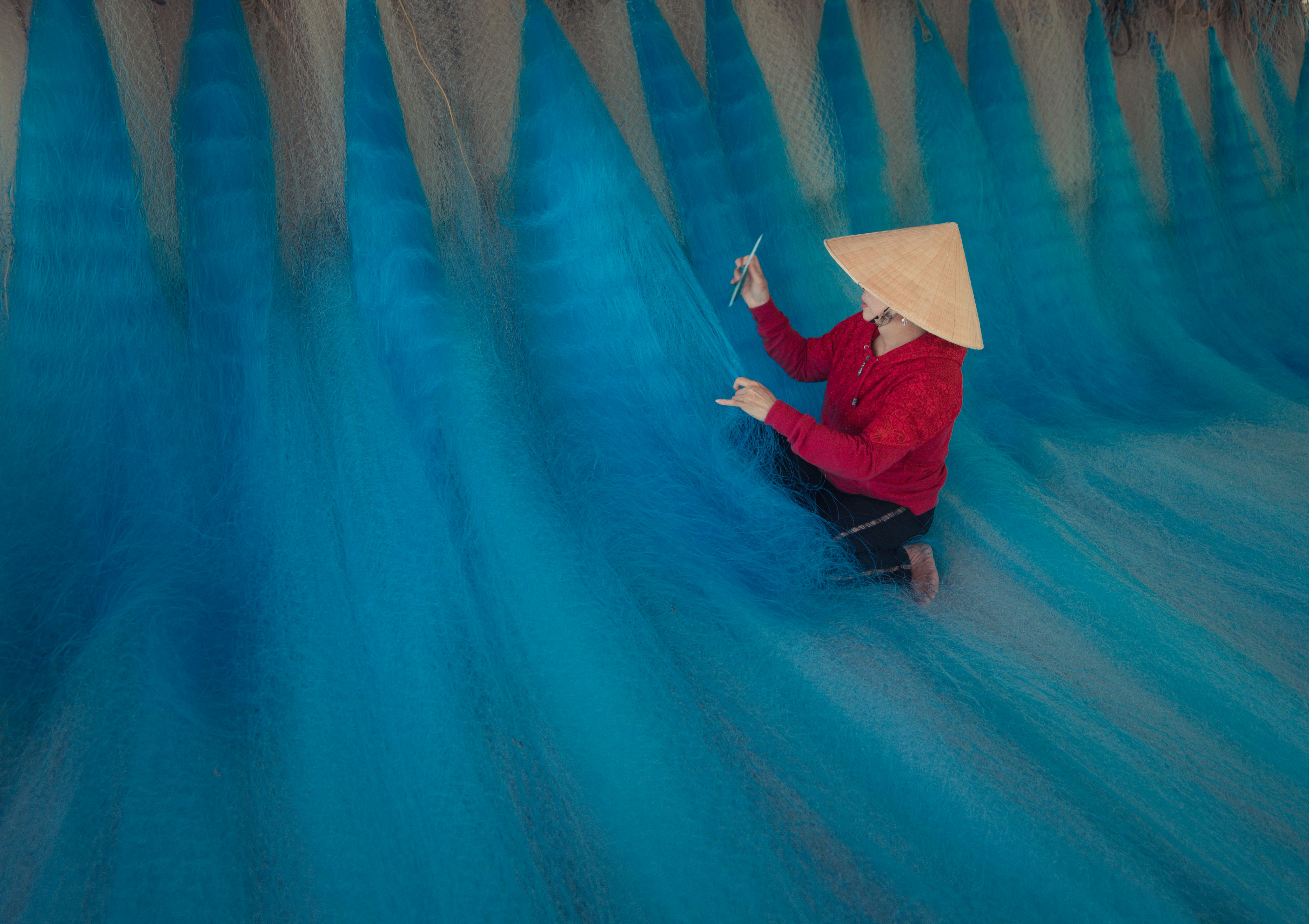 Craftsman Weaving Blue Fishing Nets Indoors · Free Stock Photo