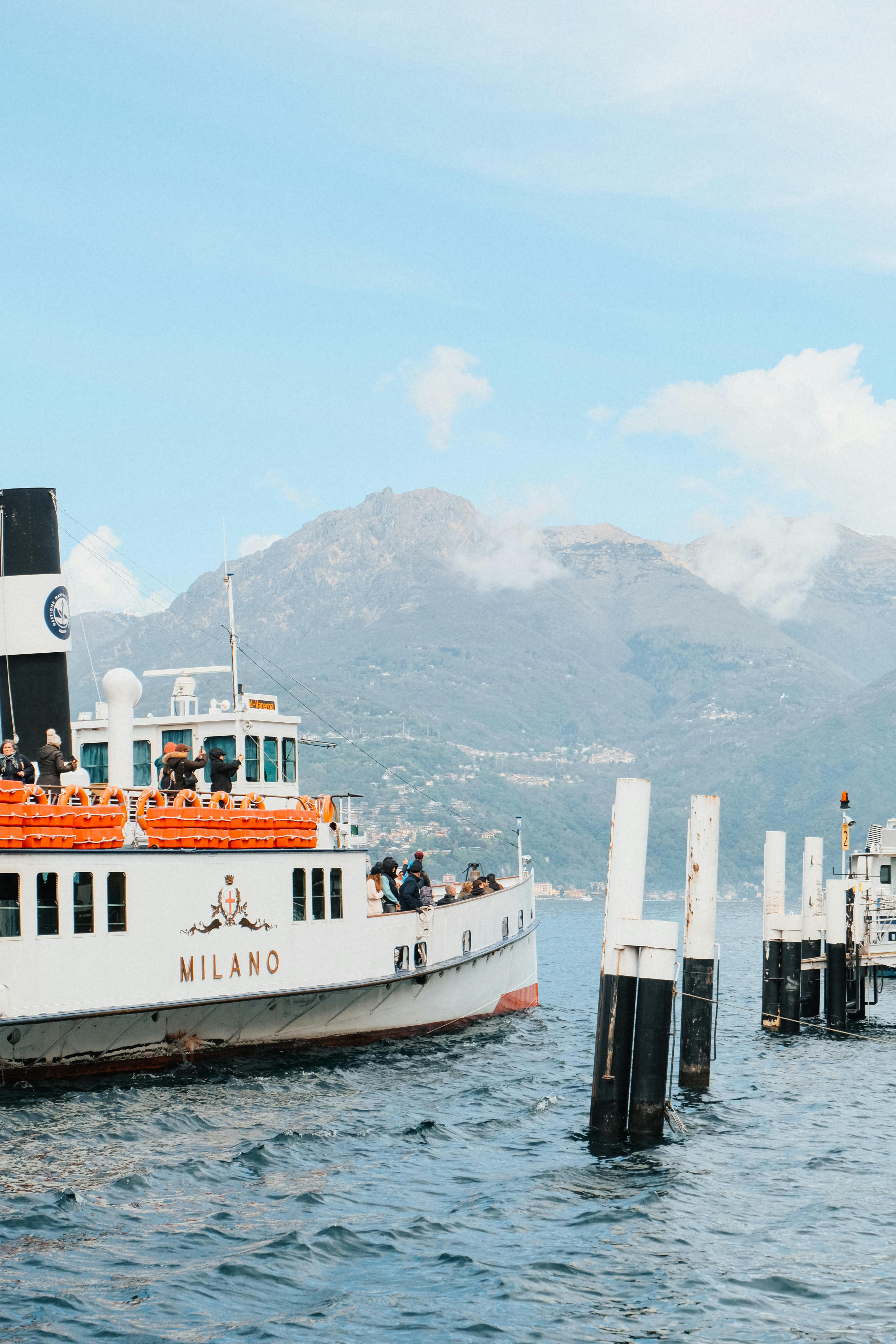Motorboat Sailing on Lake Como Surrounded by Alps · Free Stock Photo