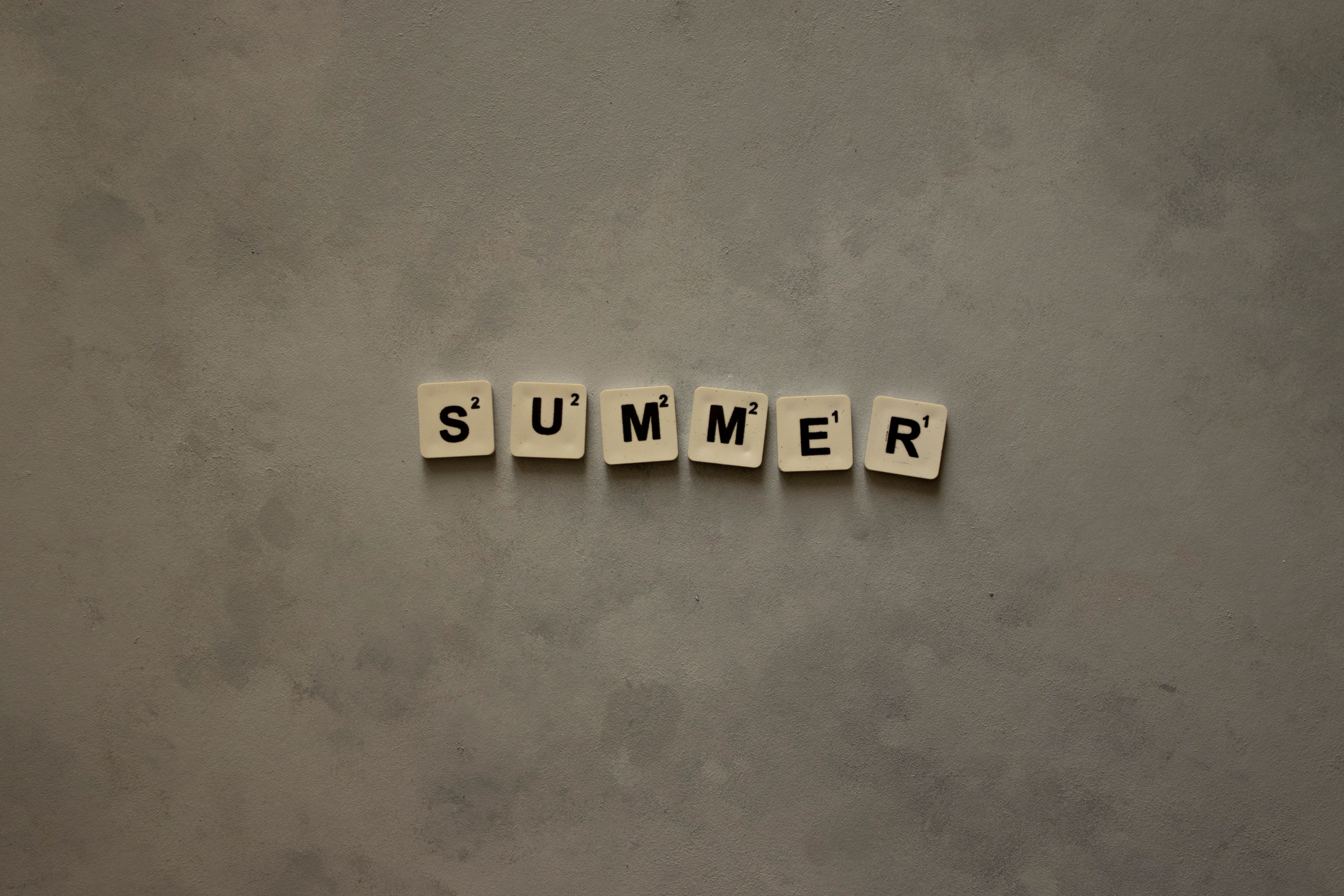 Scrabble Tiles Spelling 'Summer' on Gray Surface · Free Stock Photo