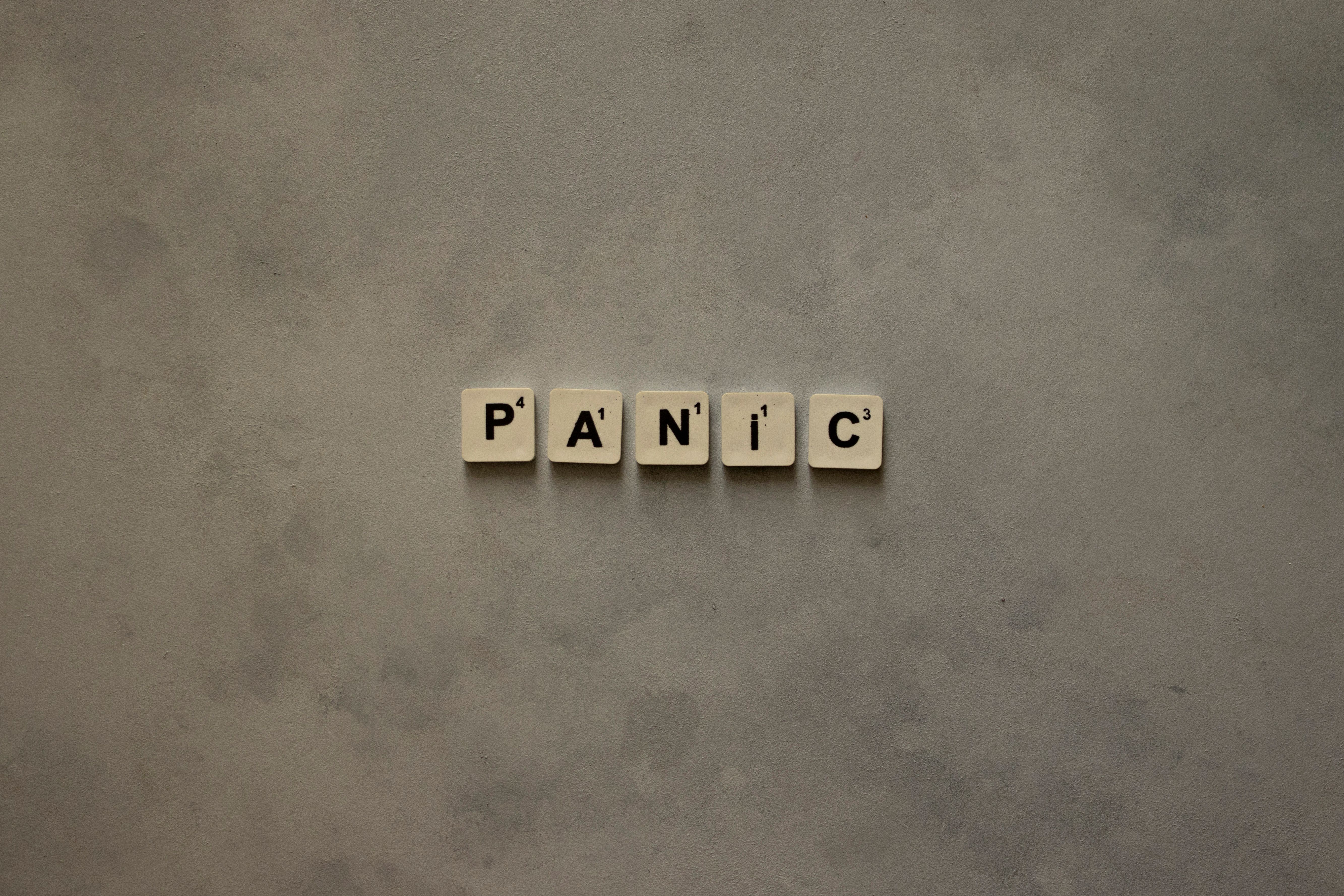 Scrabble Tiles Spelling 'Panic' on Neutral Background · Free Stock Photo