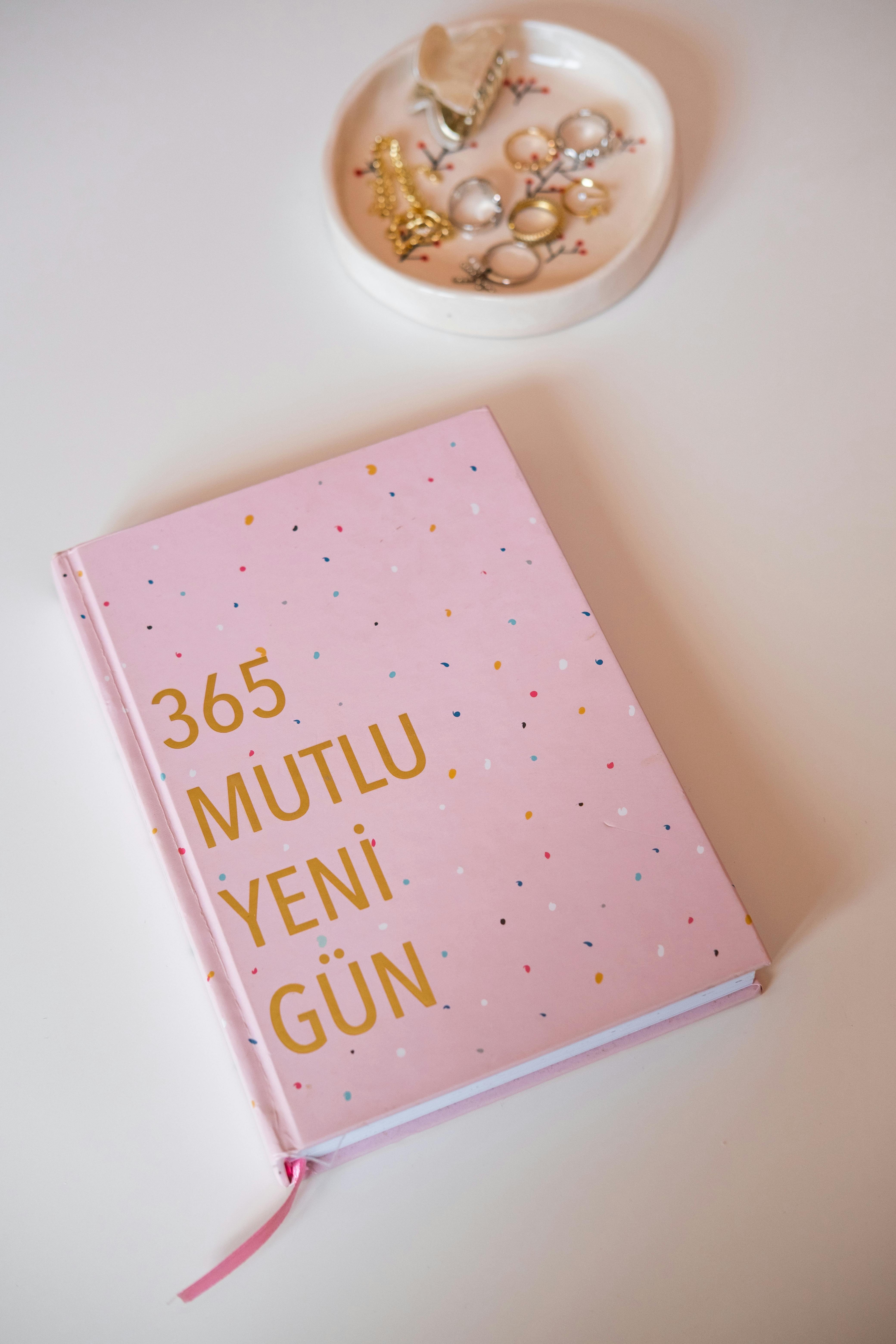 Pink Notebook with Jewelry and Pastel Confetti · Free Stock Photo