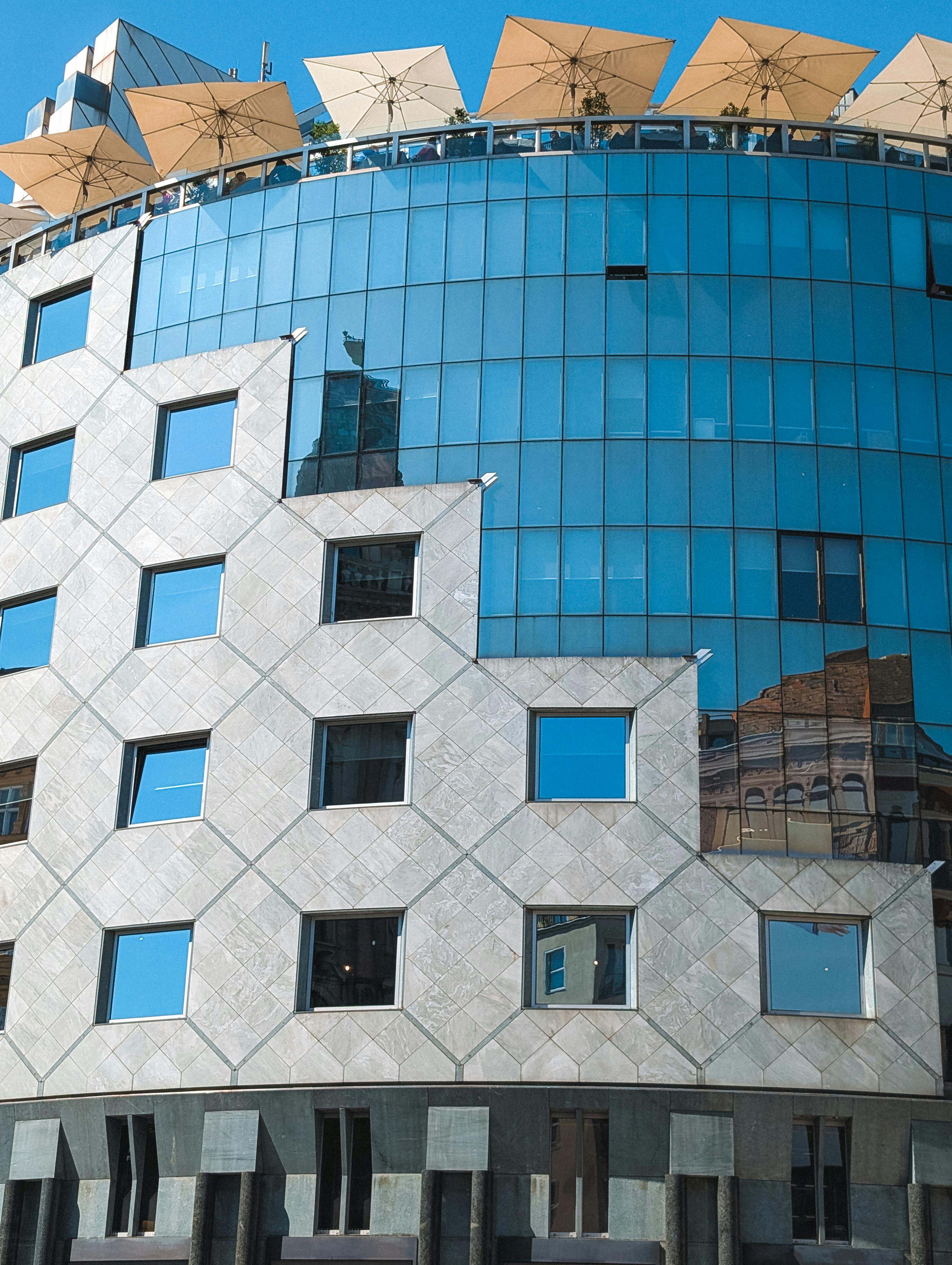 Modern Architectural Facade with Unique Glass Design · Free Stock Photo