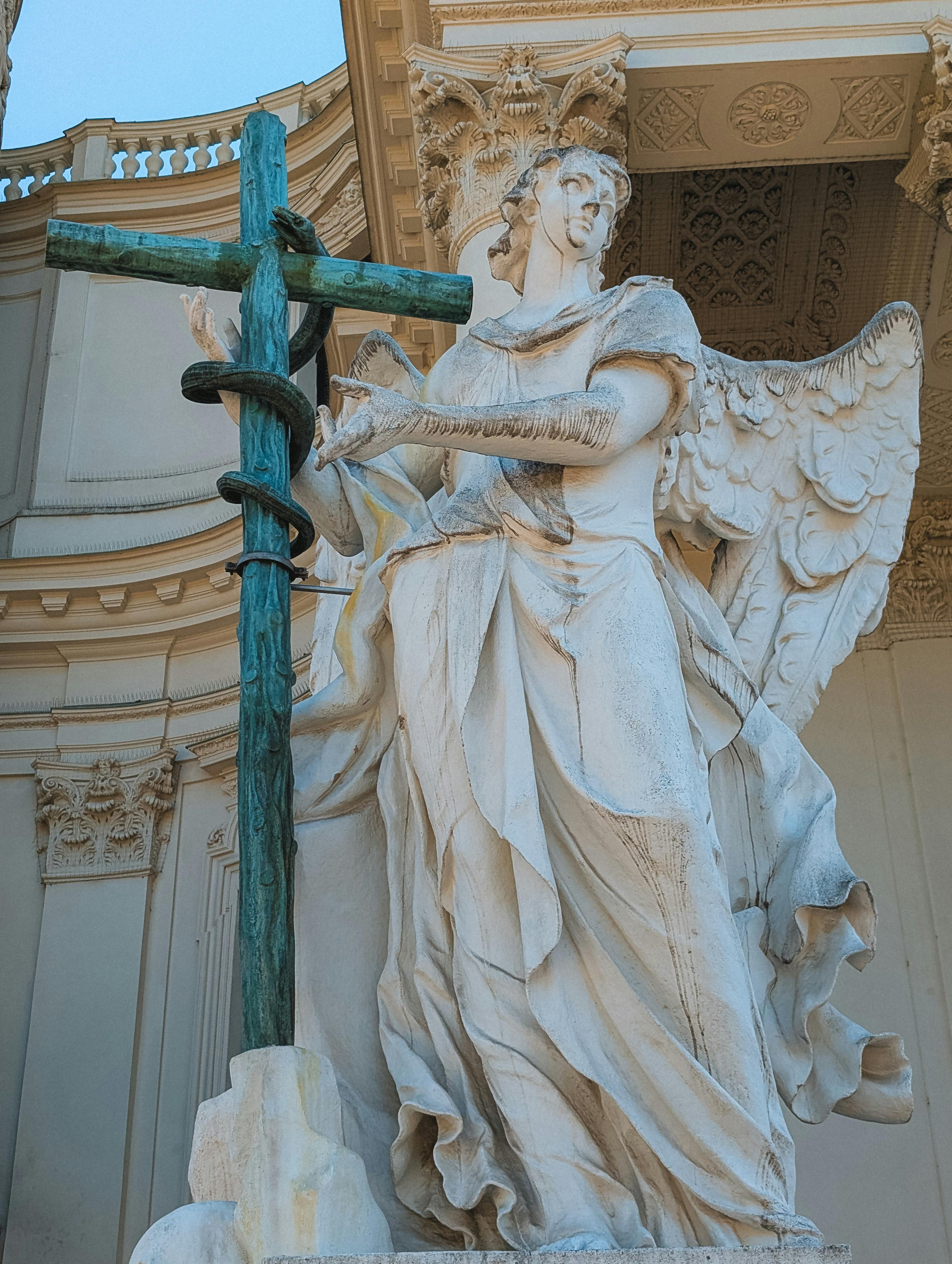 Majestic Angel Sculpture with Cross in Historic Setting · Free Stock Photo