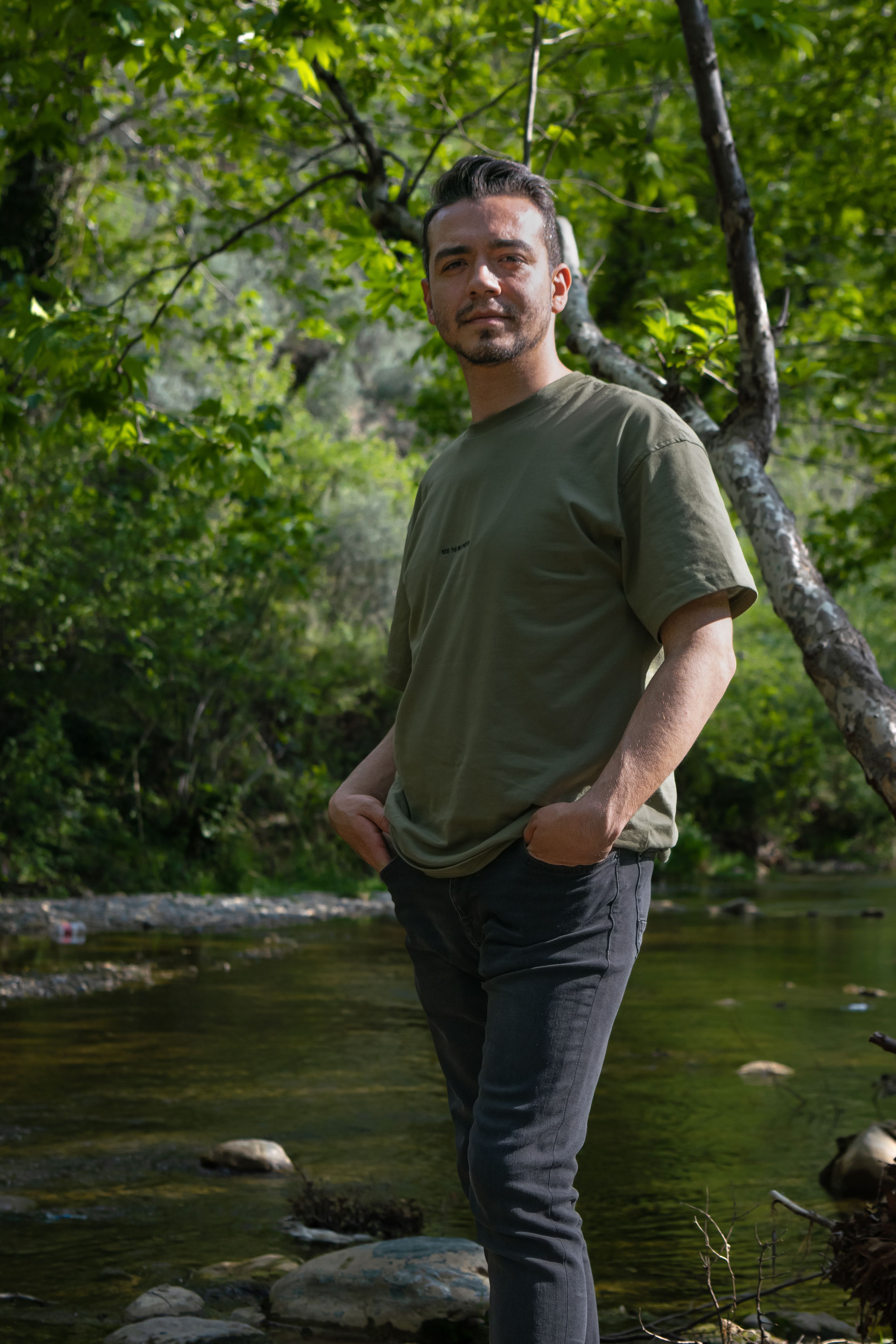 Man in Nature by a River in Greenery · Free Stock Photo