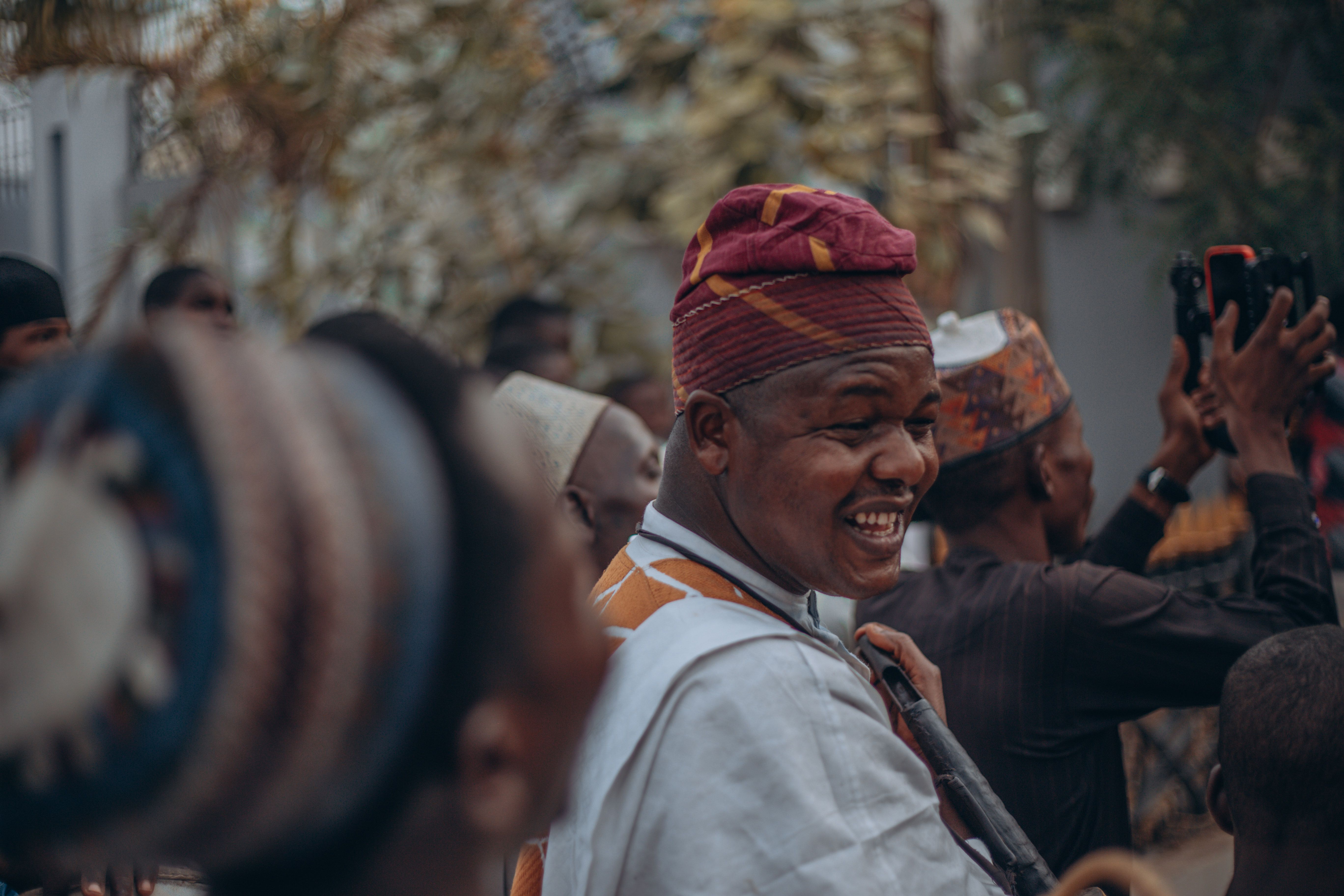 Joyful Gathering with Traditional Hats and Smiles · Free Stock Photo
