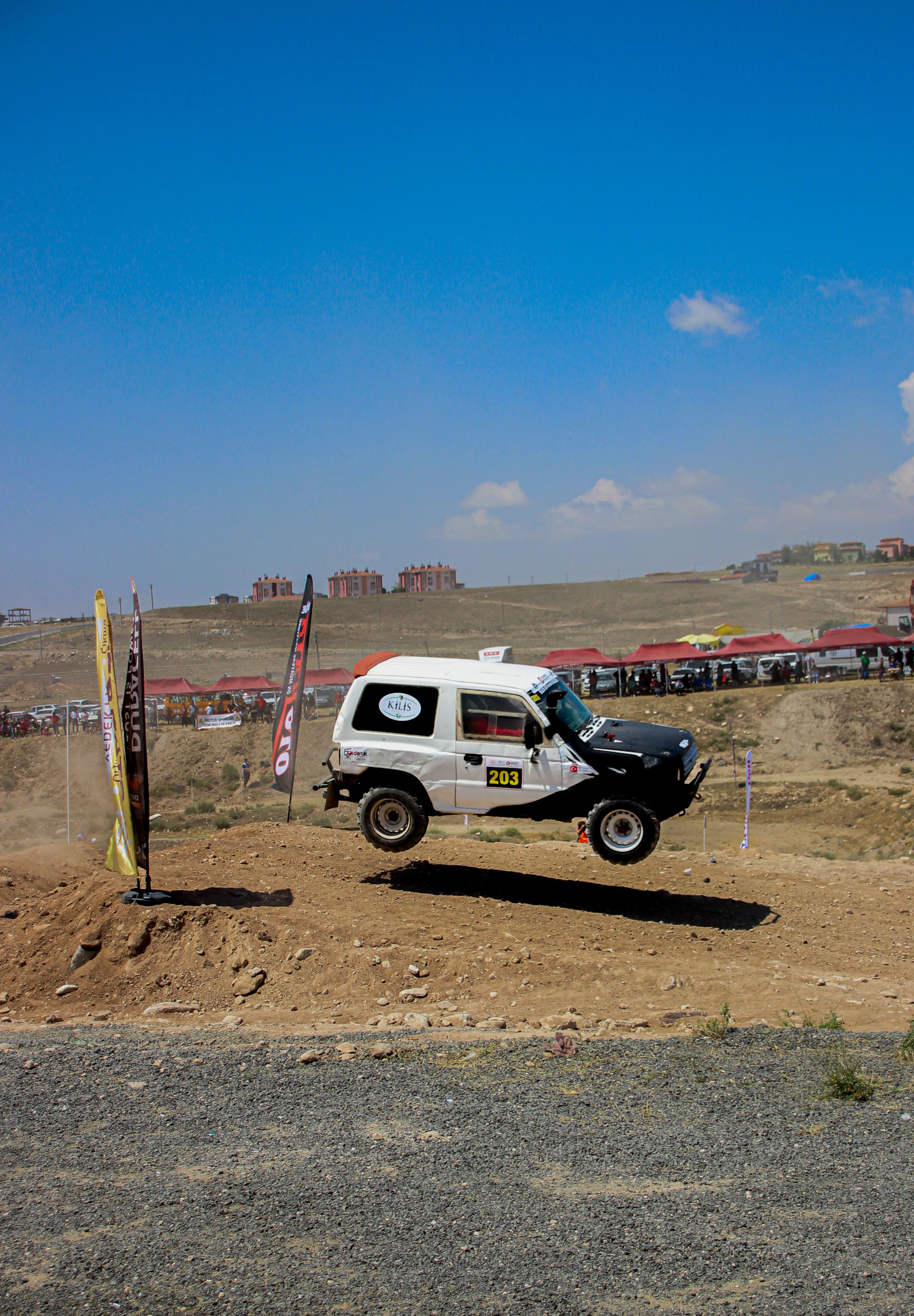 Off-Road Vehicle Jumping at Rally Event · Free Stock Photo