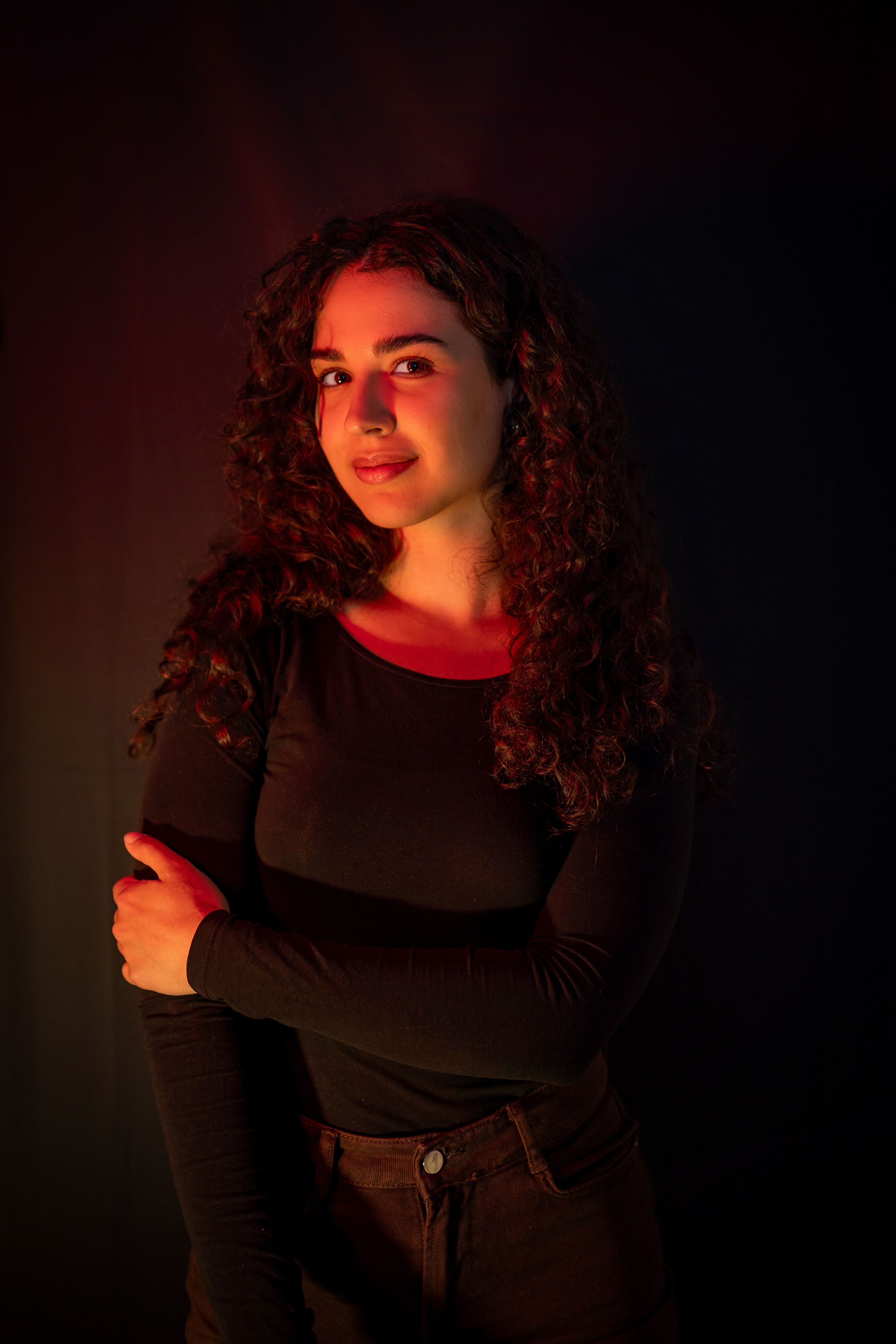 Portrait of a Smiling Woman in Moody Lighting · Free Stock Photo