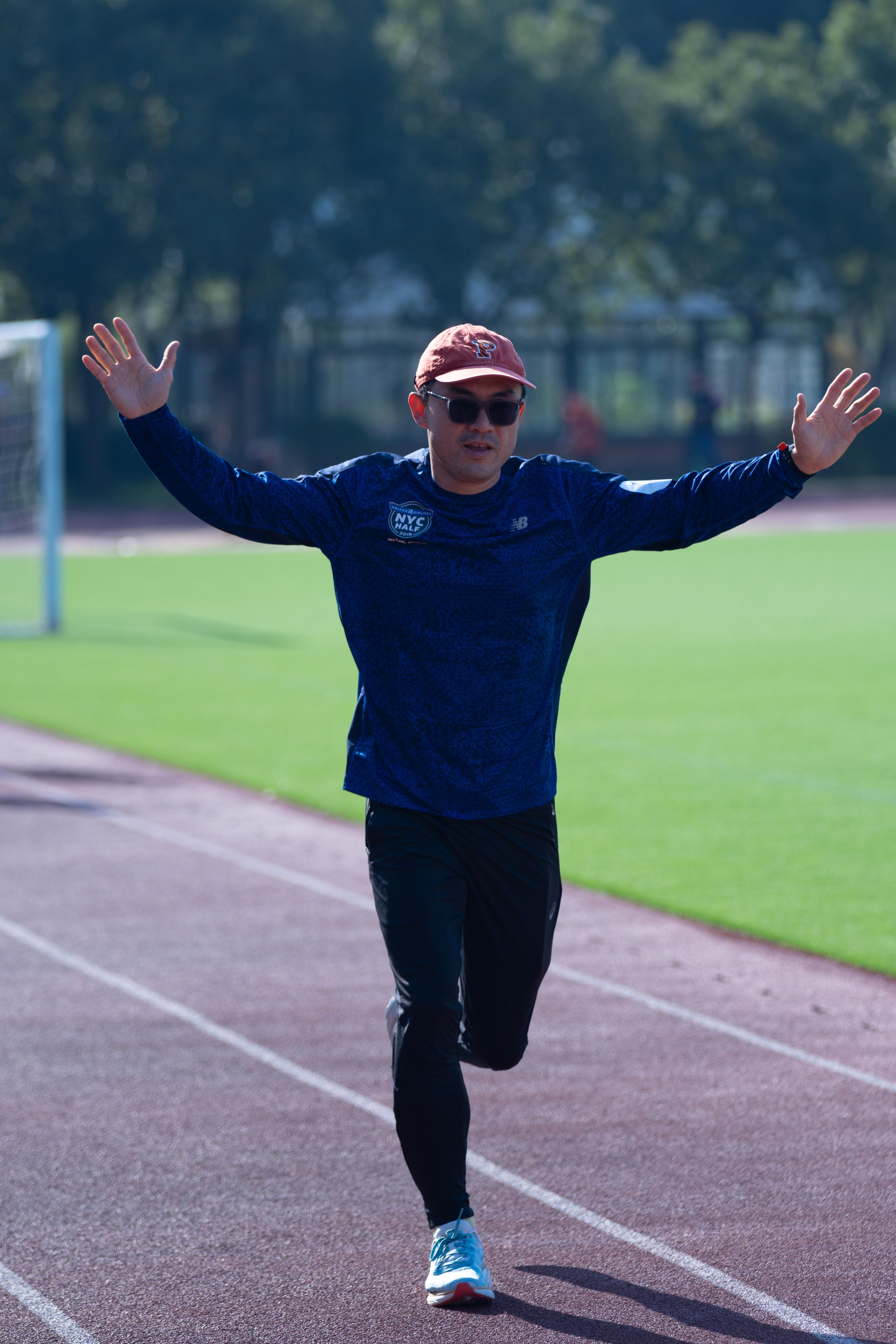 Runner Celebrates Victory on Outdoor Track · Free Stock Photo